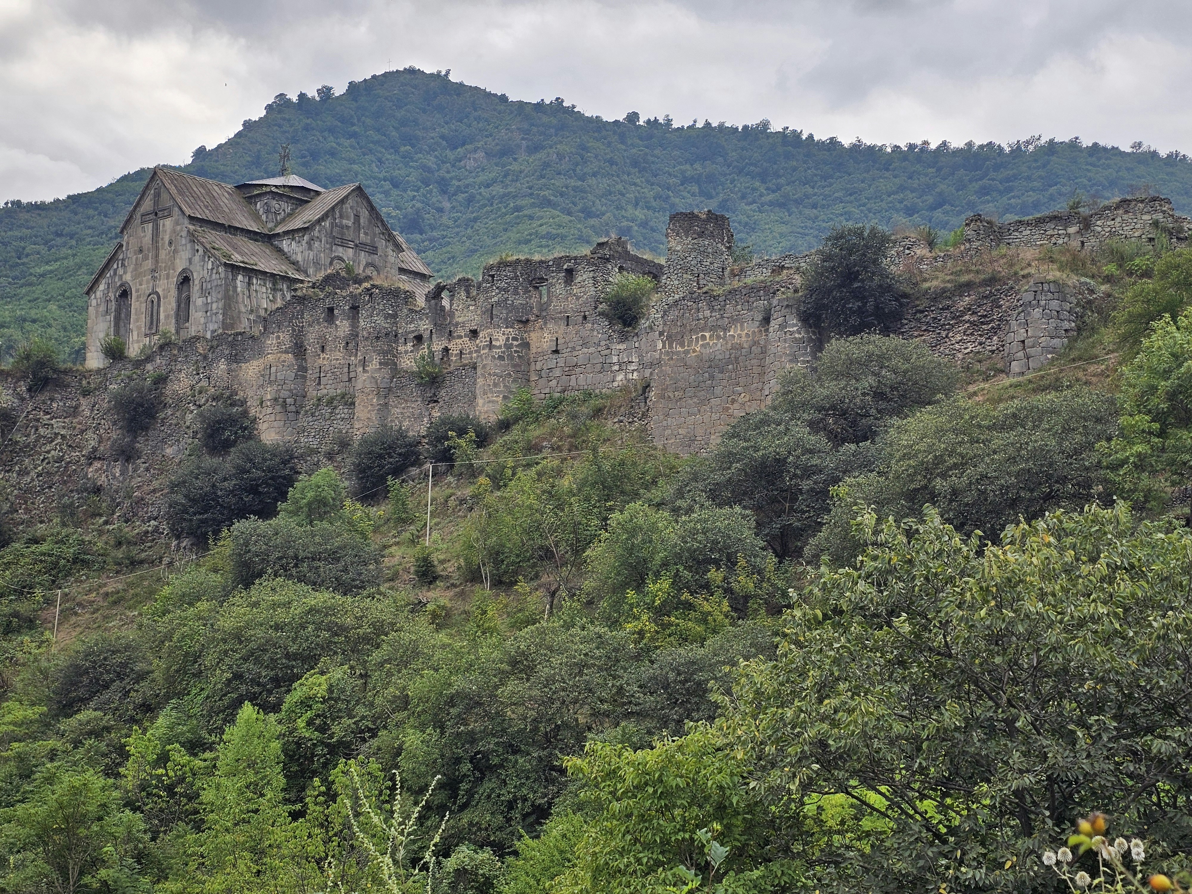 Verdant Ridge Fortress: Weathered Ruins Crowned by Green Slopes