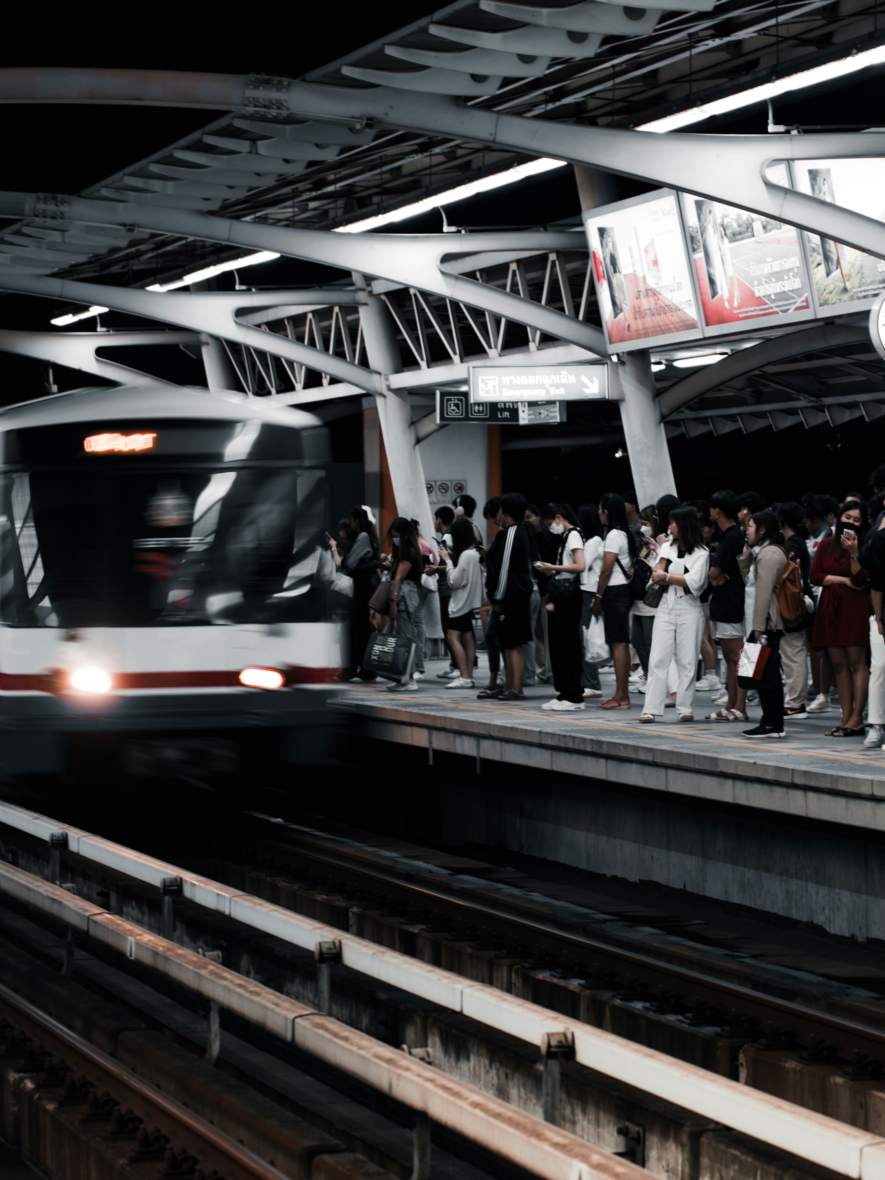Edge of Arrival: A Night Metro Slips In Among the Waiting Crowd