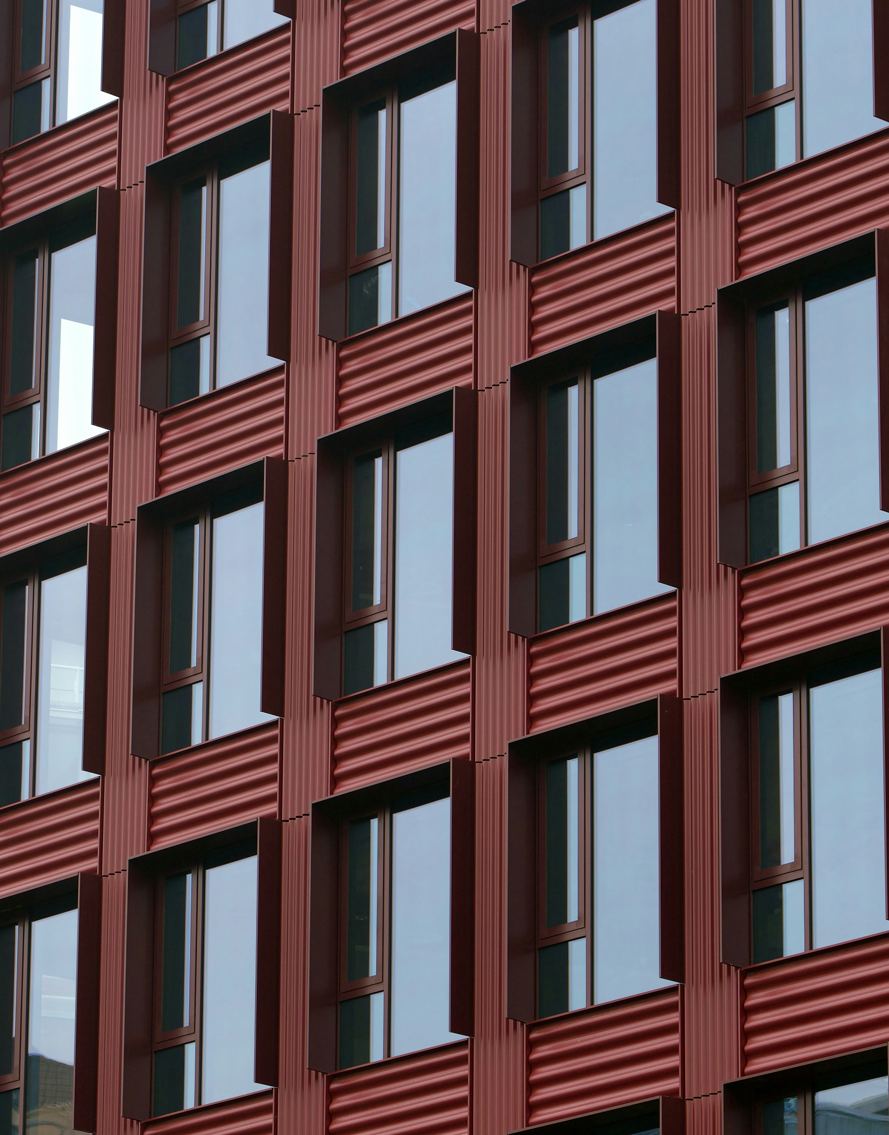 A tall red building with lots of windows photo – Free Building Image on ...