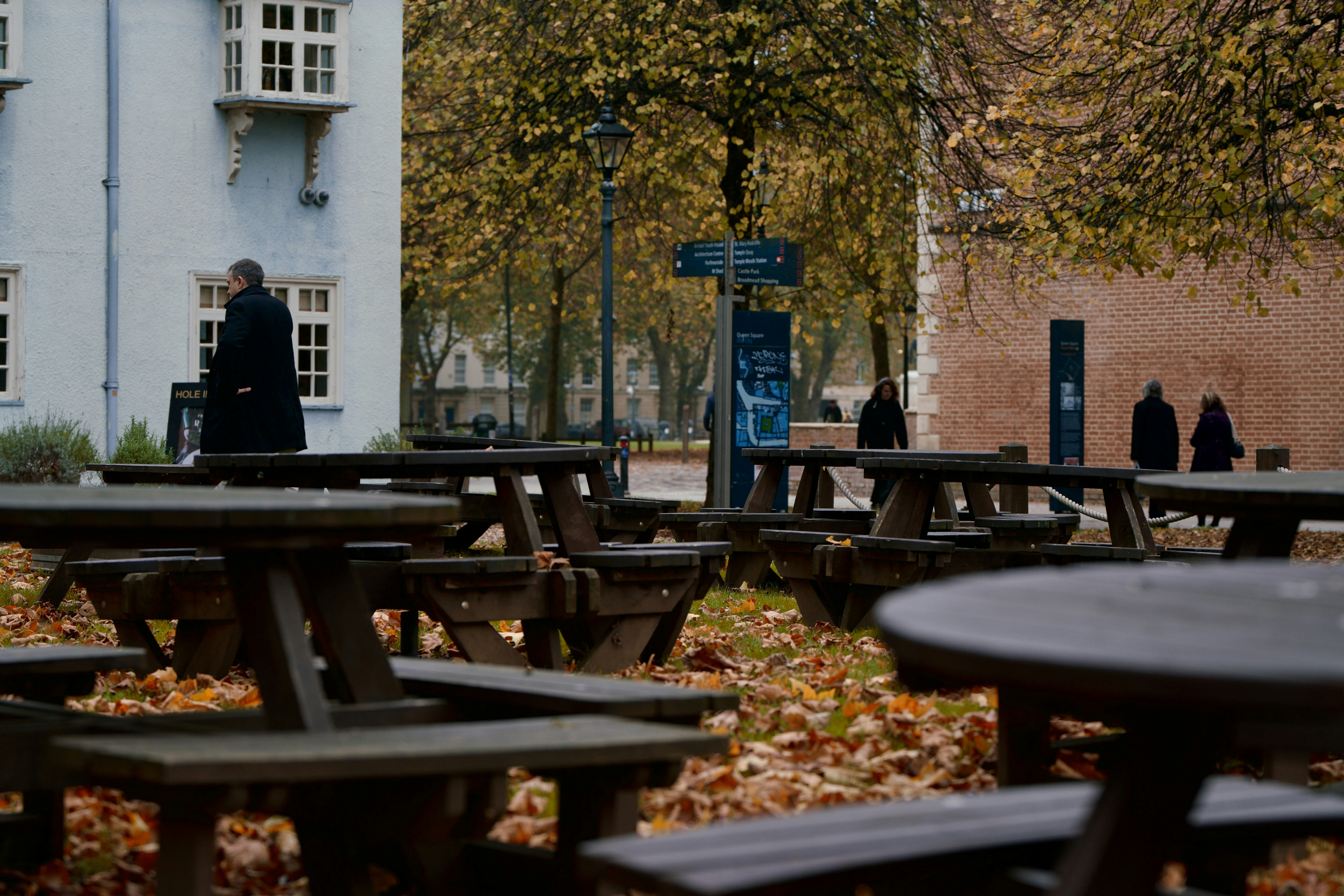 Autumn Calm in a Bench-Lined Square: A Quiet Stroll Past Fallen Leaves