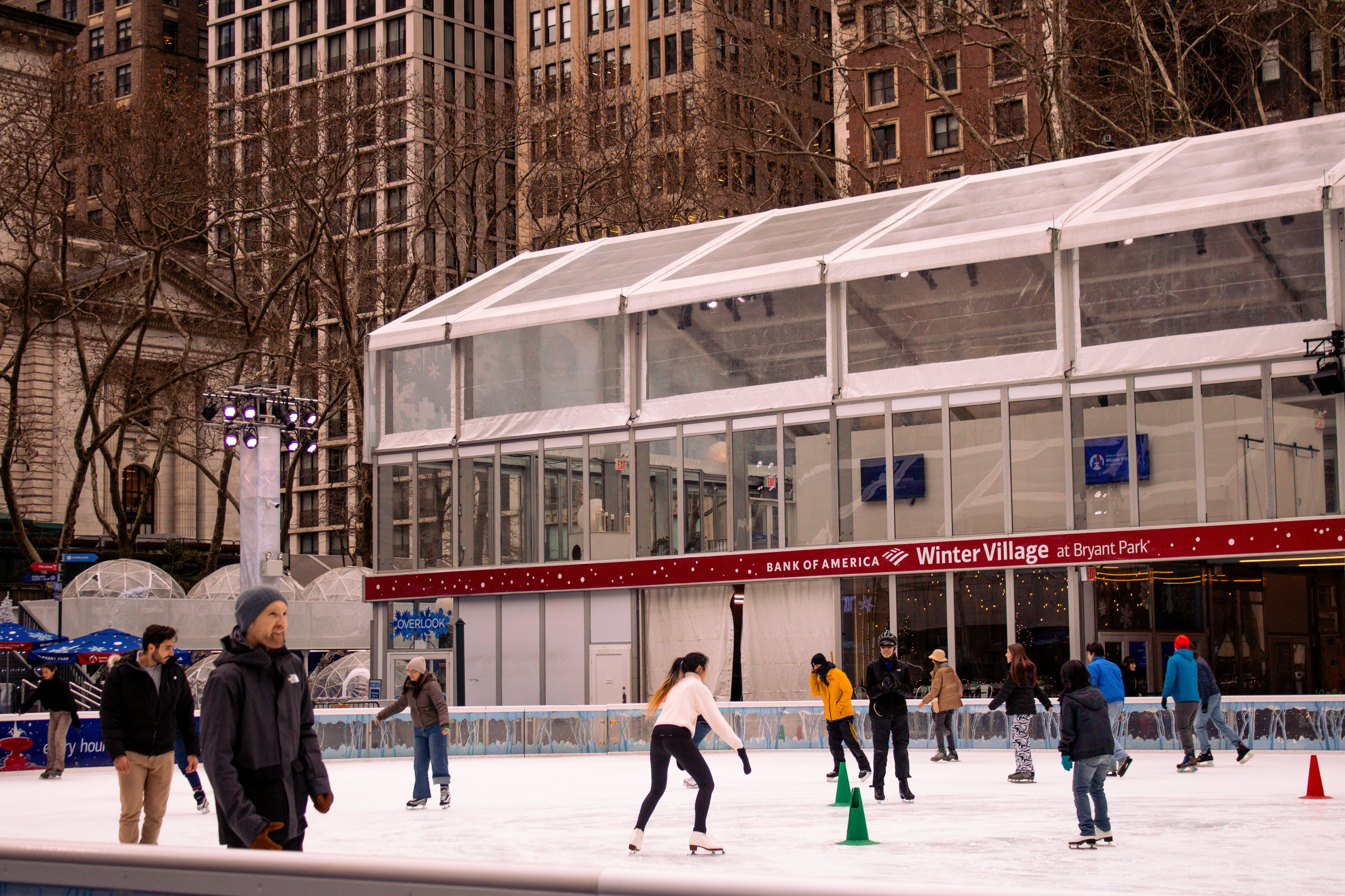 A group of people skating on an ice rink photo – Free Bryant park Image ...