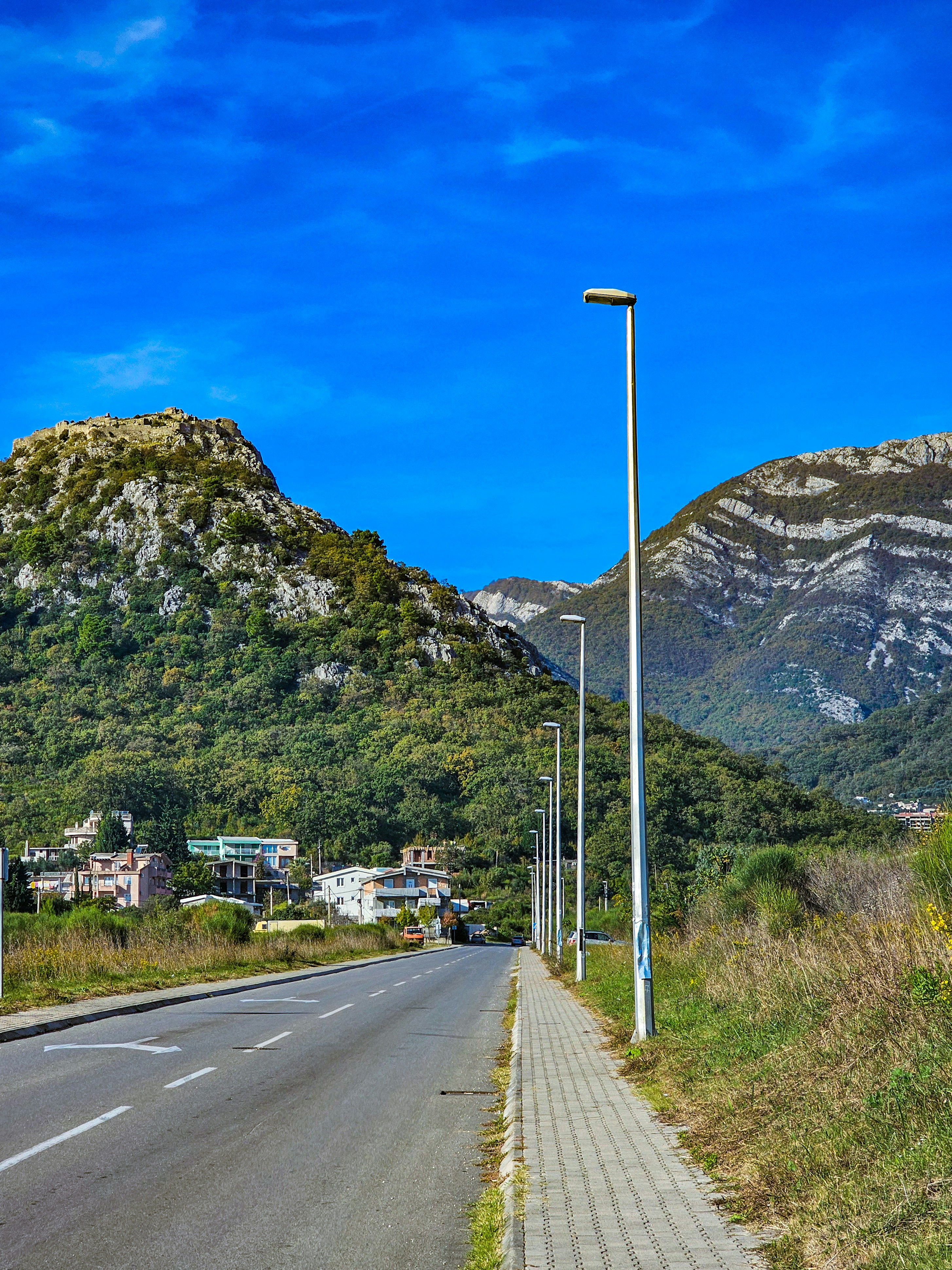 Cobalt Sky Over a Quiet Mountain Road Toward the Crest