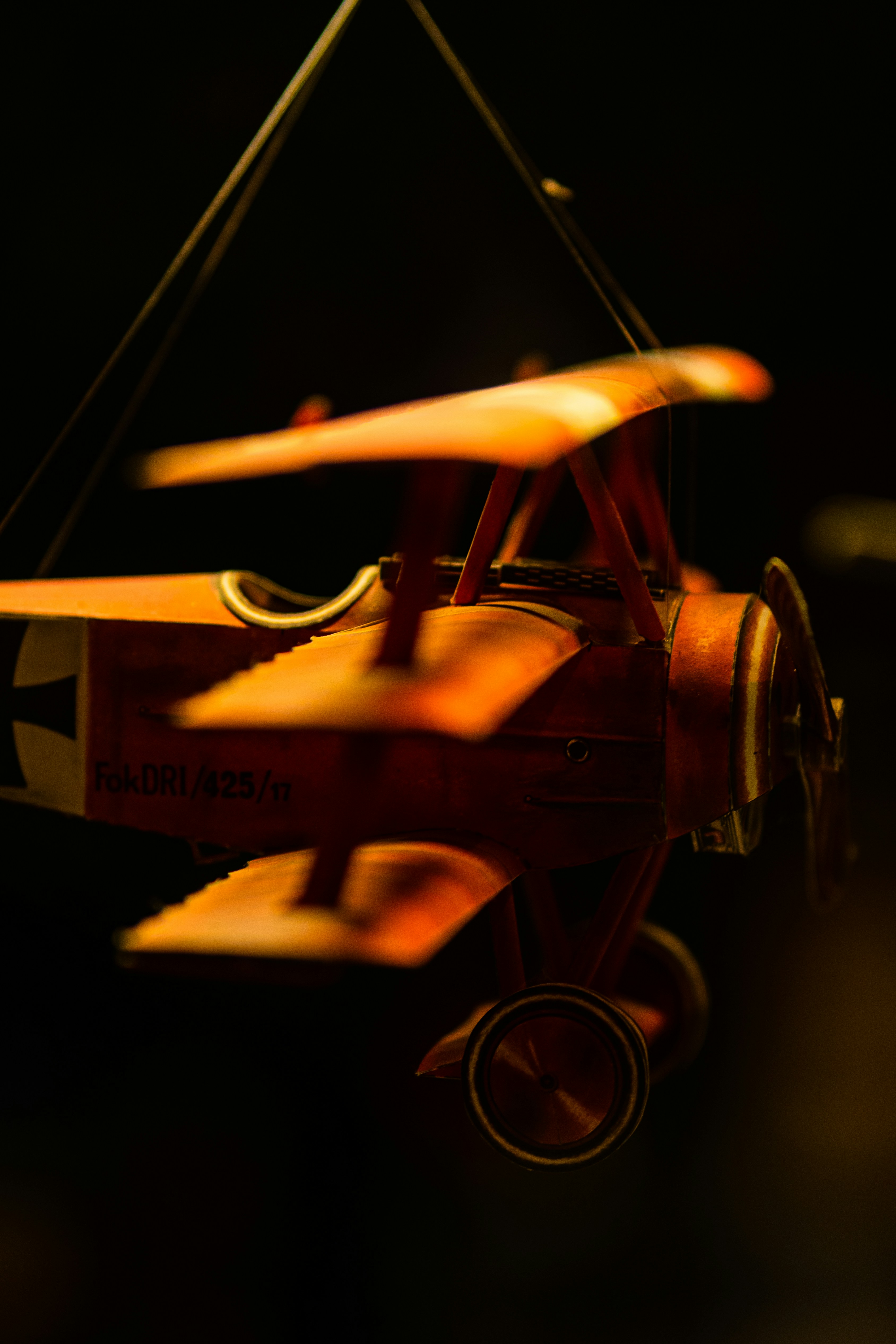 Amber Wings Under Velvet Light: A Suspended Vintage Biplane