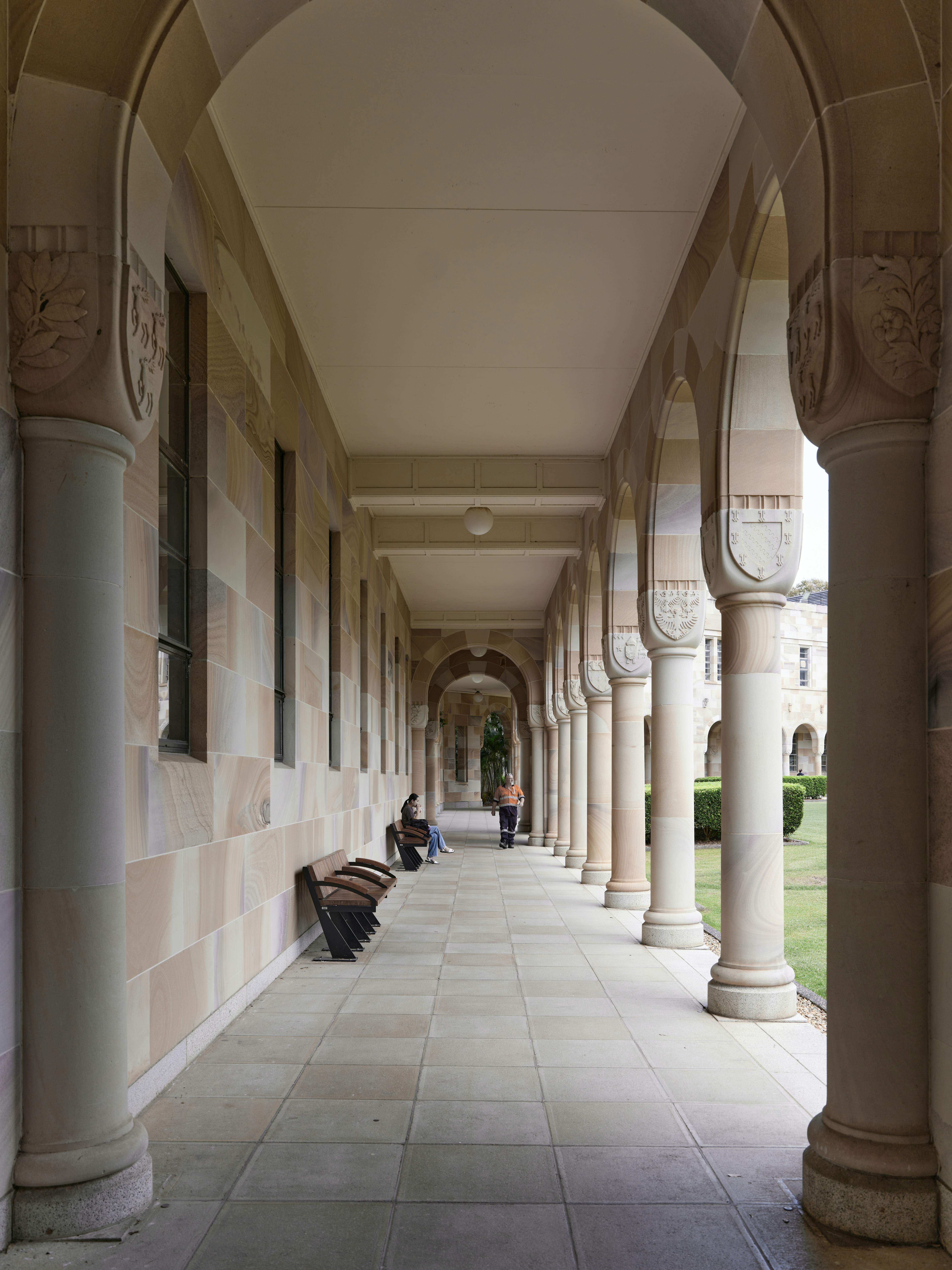 A long hallway lined with columns and benches photo – Free Books Image ...