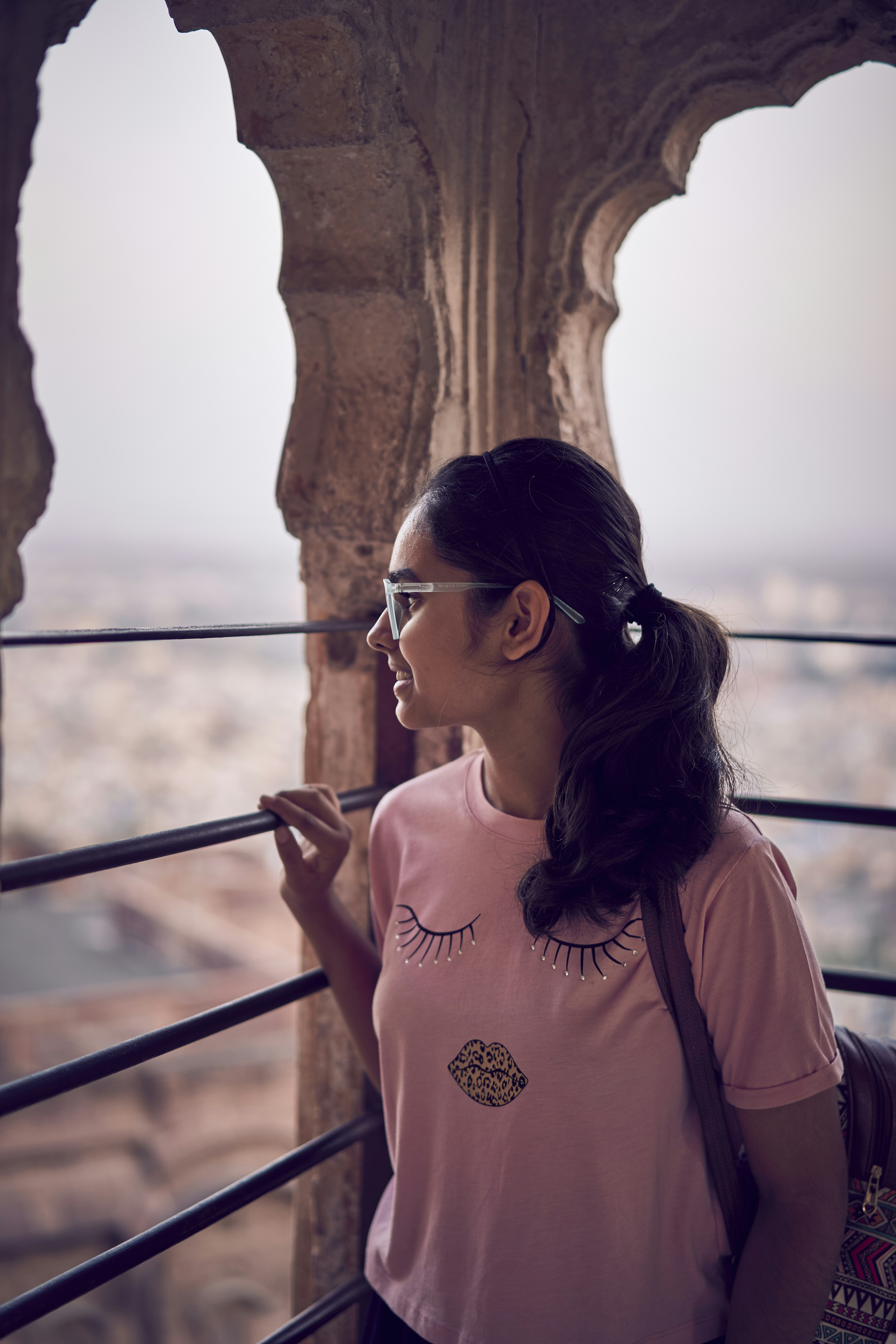 Portrait on the Balcony: A Quiet Gaze Among Stone Arches
