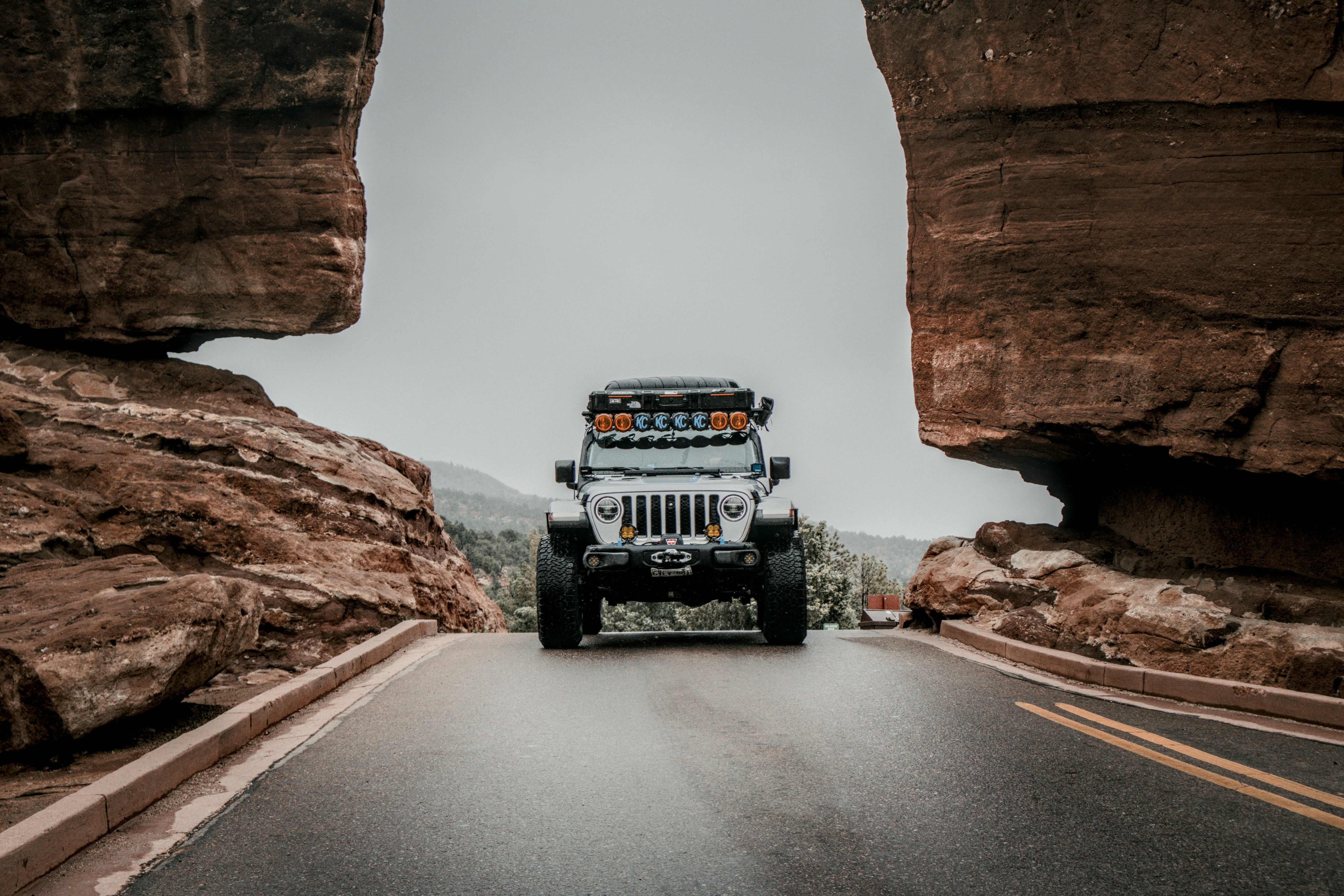 A jeep driving through a gap in the rocks photo – Free Wallpaper Image ...