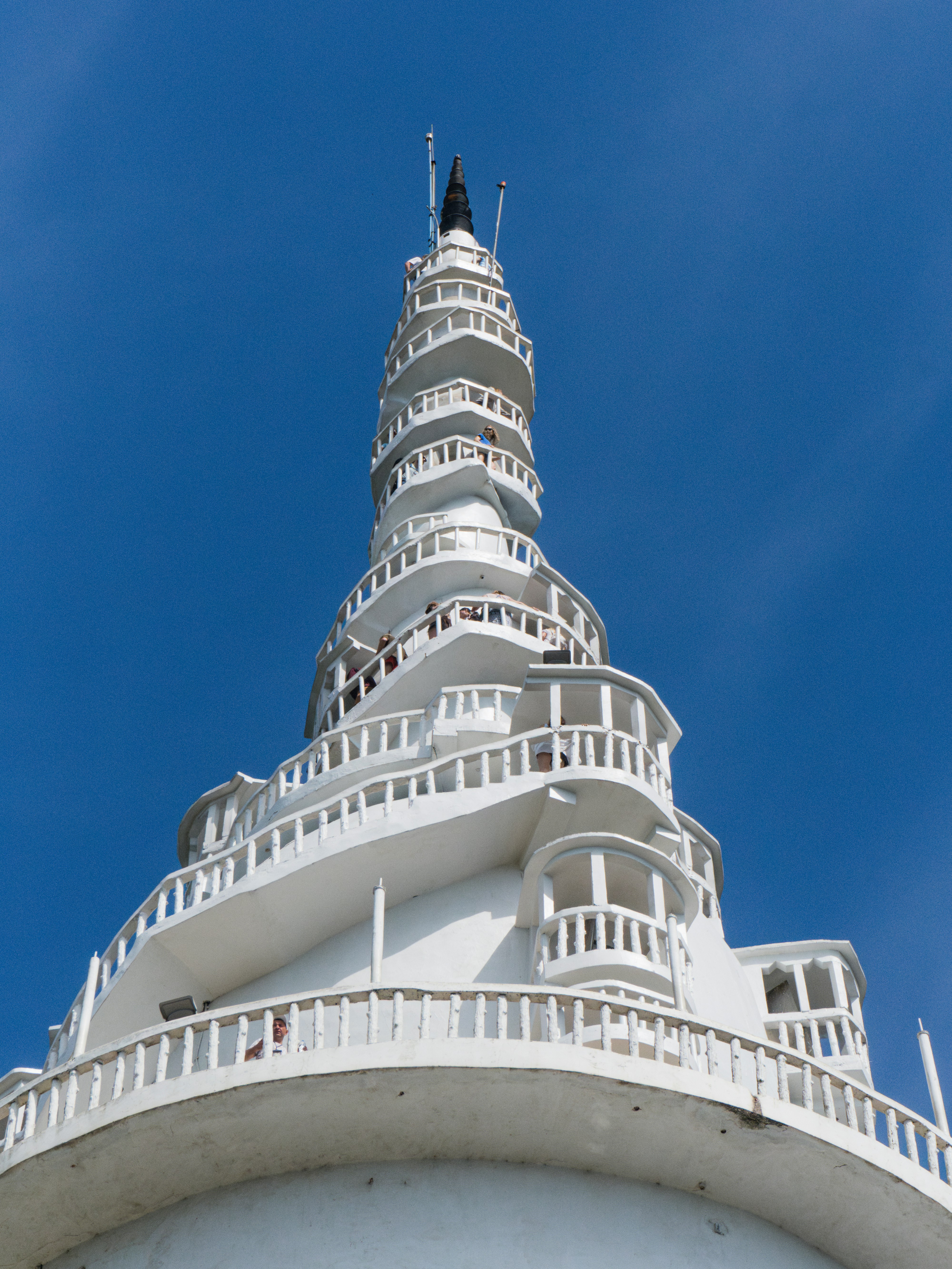 Spiral Summit: The White Tower Ascends Against a Pristine Blue Sky