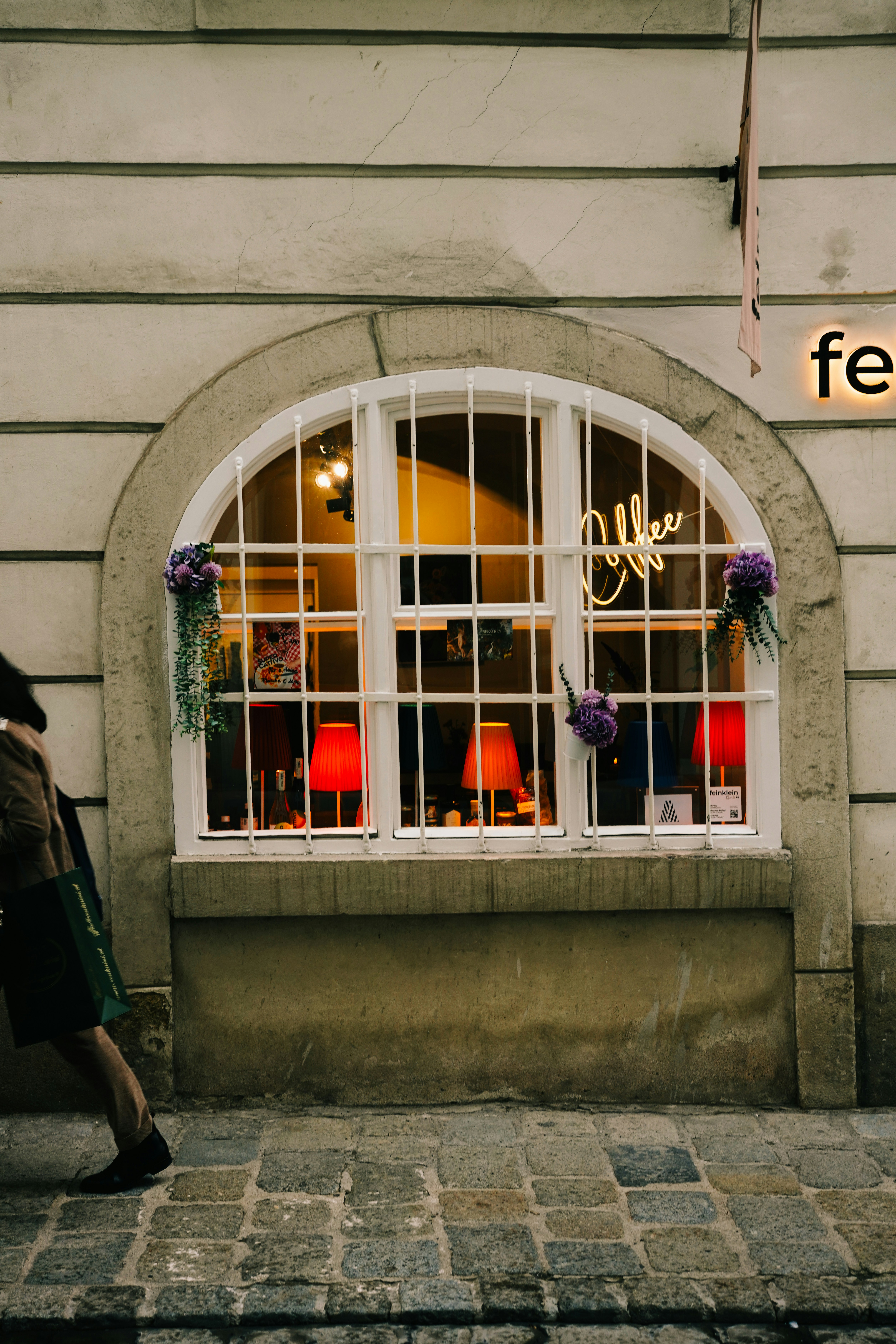 A woman walking down a street past a building photo – Free Vienna Image ...