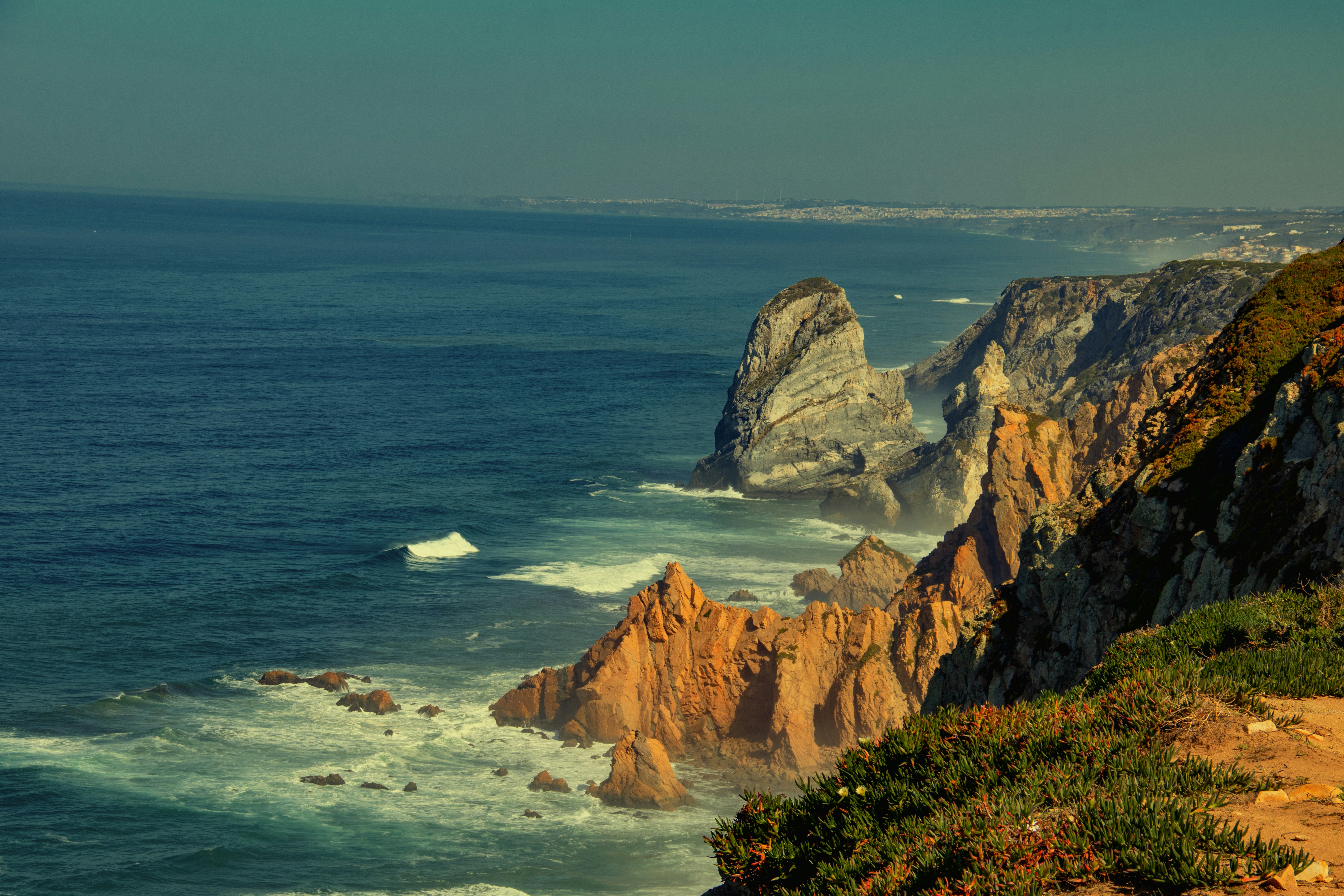 Crimson Cliffs Guard the Quiet Atlantic