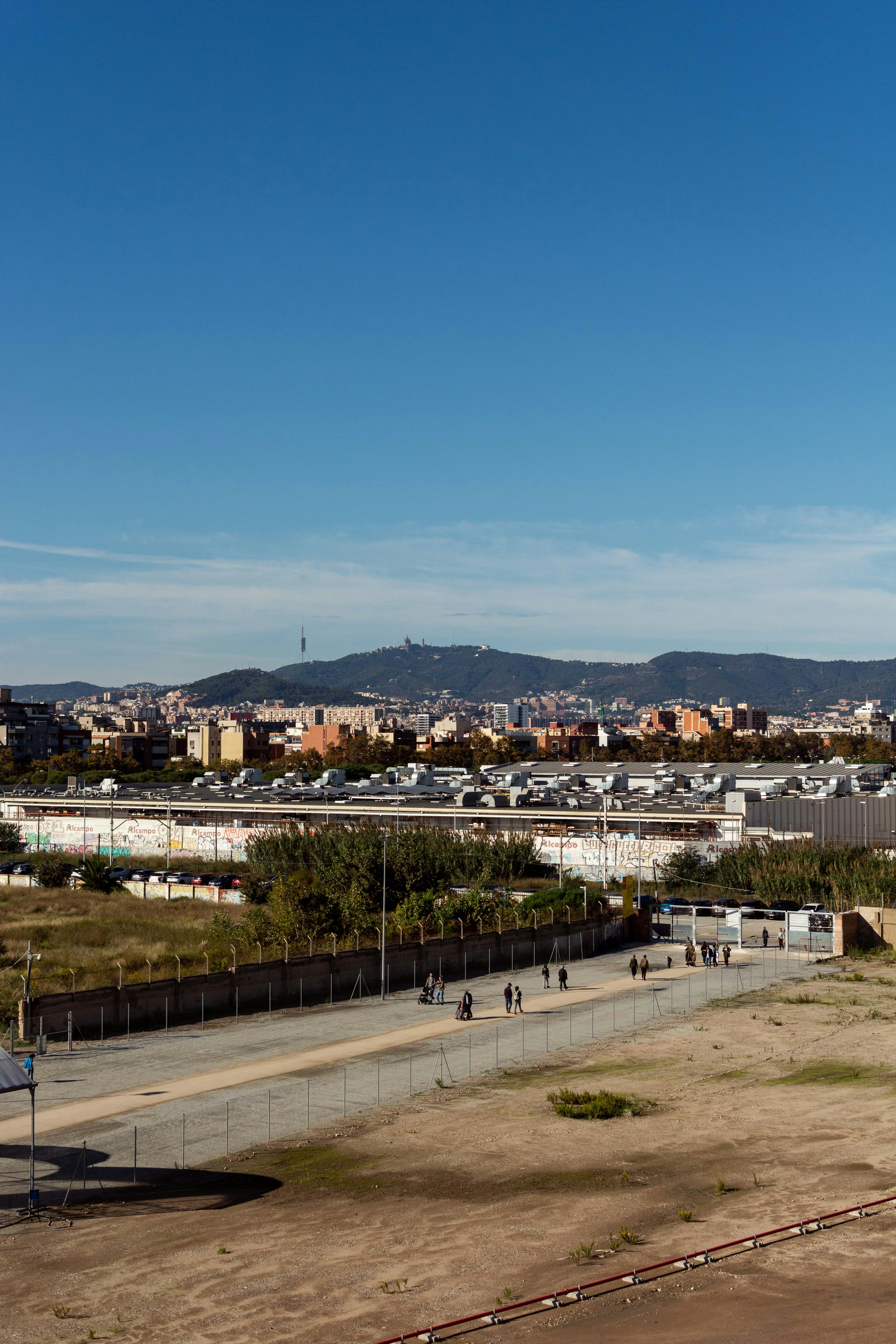 Horizon Fringe: Hills, Warehouses, and a Calm Blue Sky