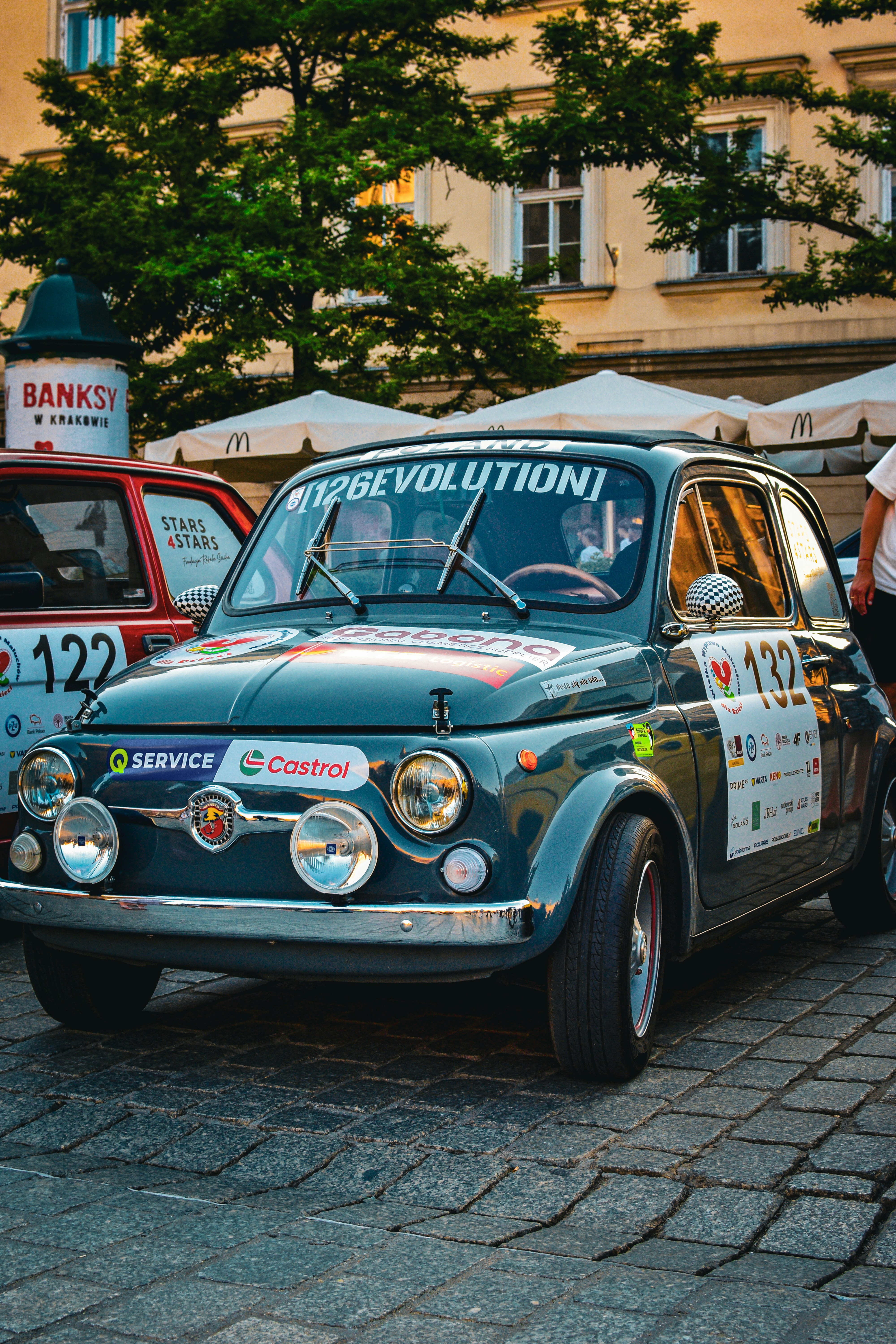 Cobblestone Rally: The Blue Classic Car Anchoring a Street Stage