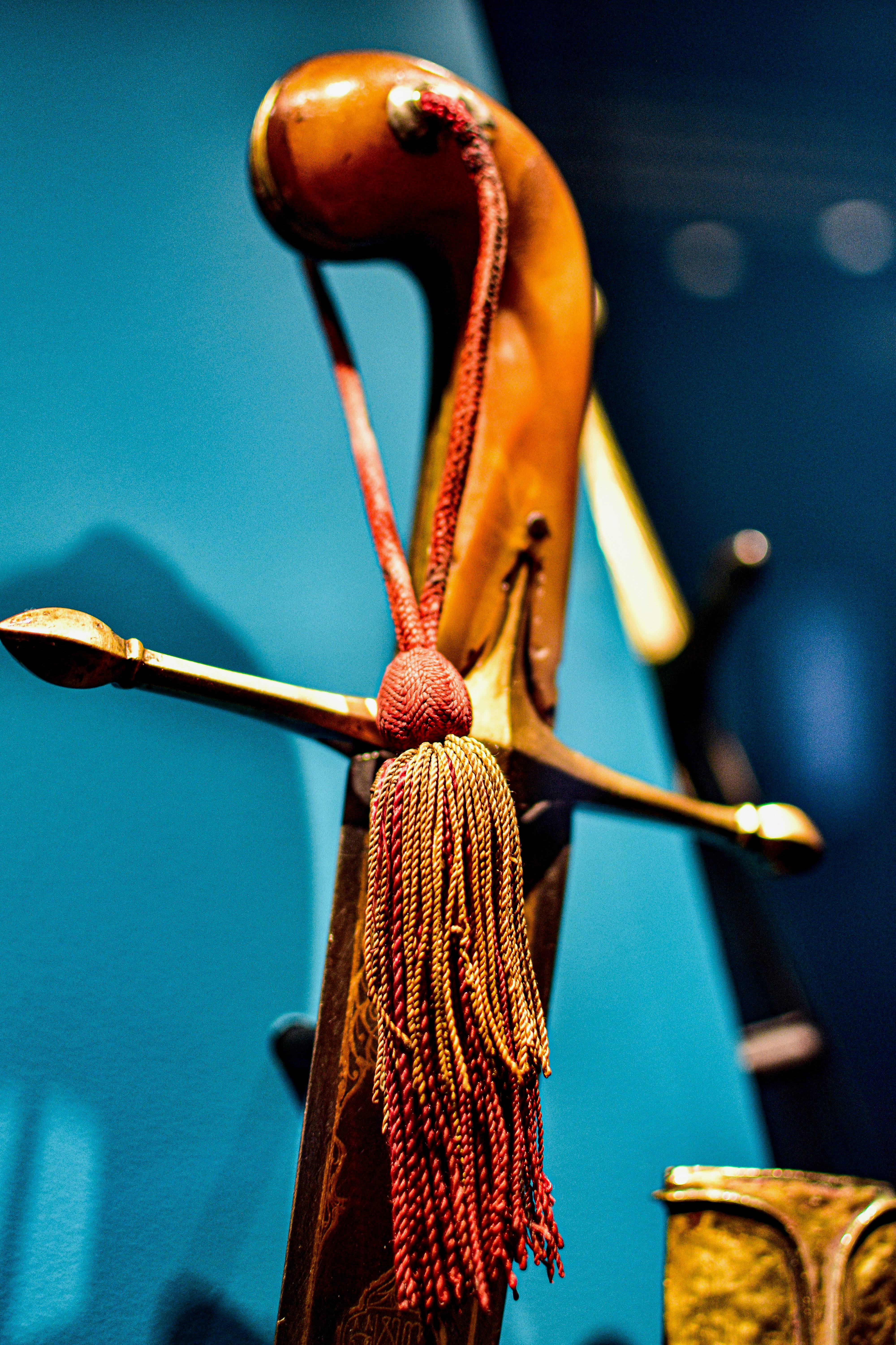 Red Tassel Knot on a Lacquered Ceremonial Staff, Close-Up