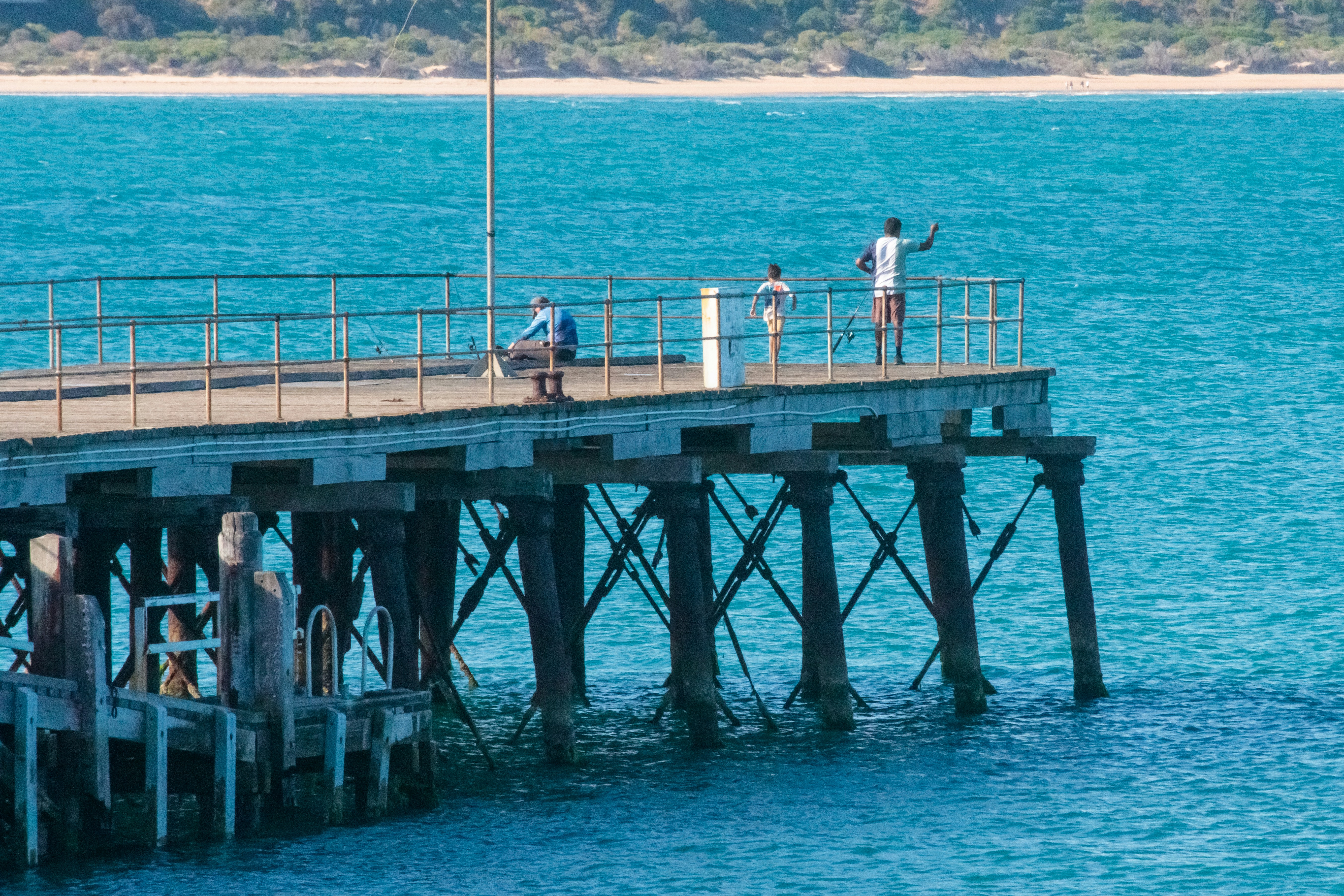 A group of people standing on top of a pier photo – Free Granite island ...