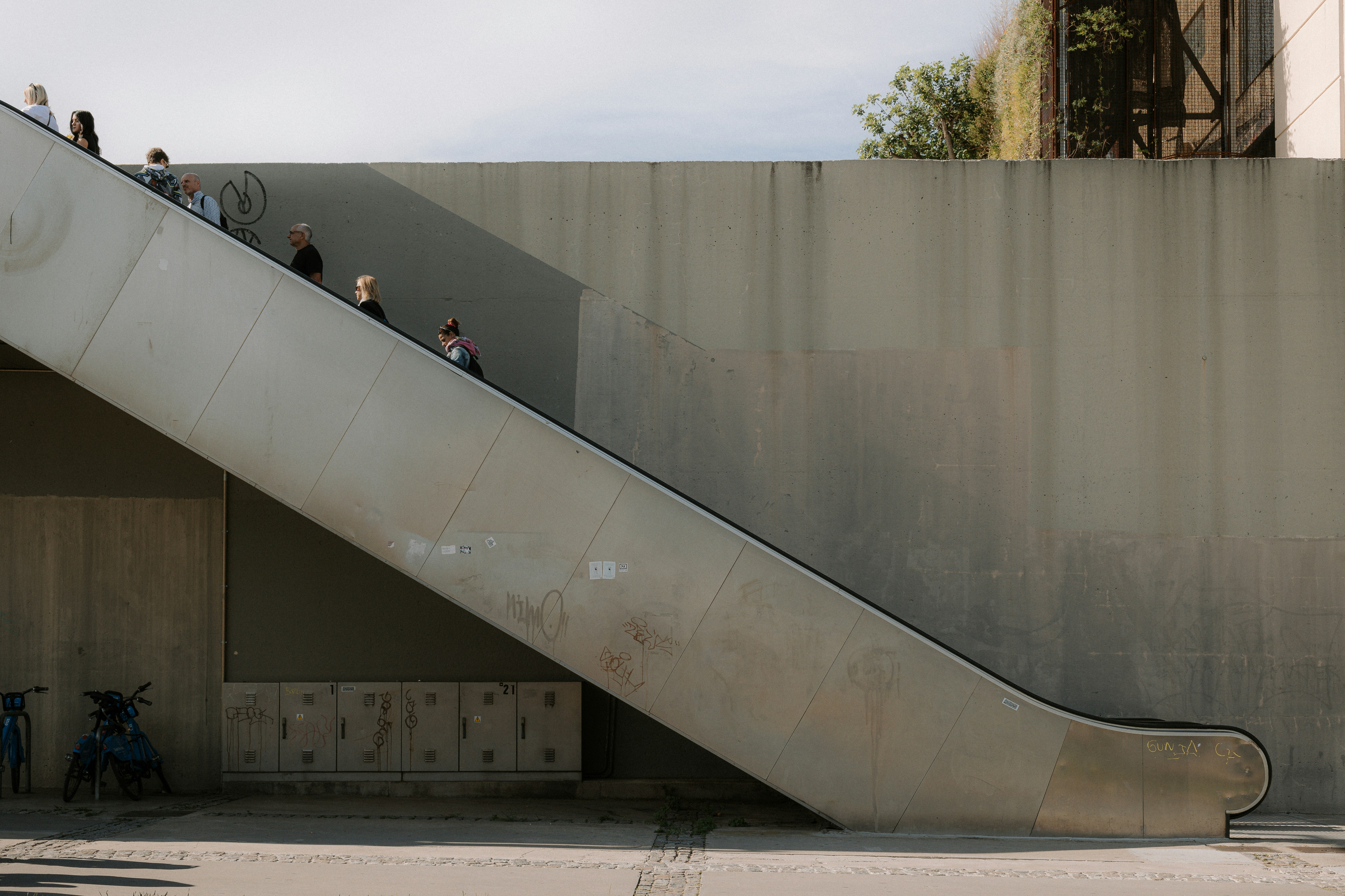 Diagonal Descent: Quiet Figures on a Minimalist Concrete Ramp