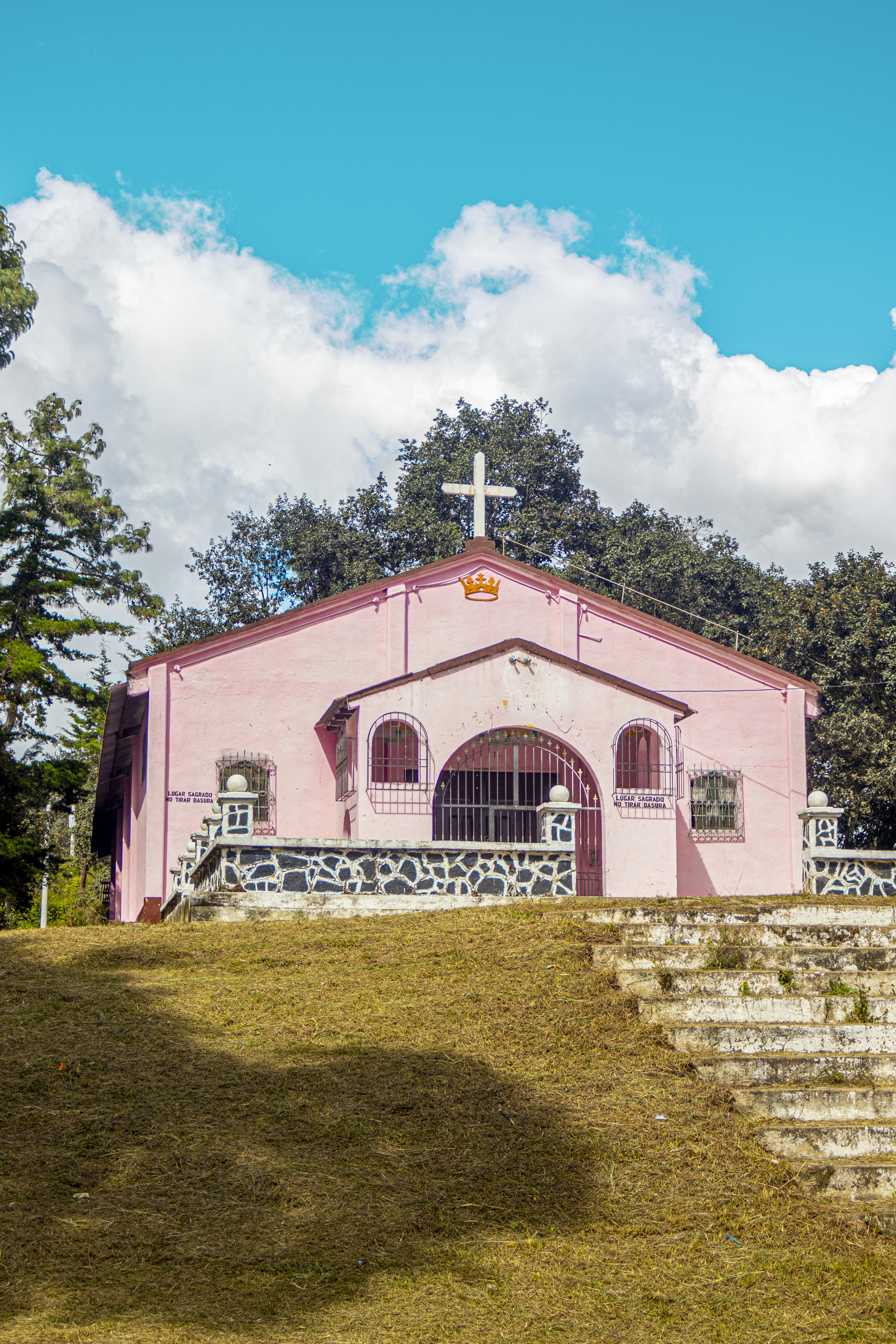 Pastel Chapel on a Bright Blue Day: Pink Walls, White Cross