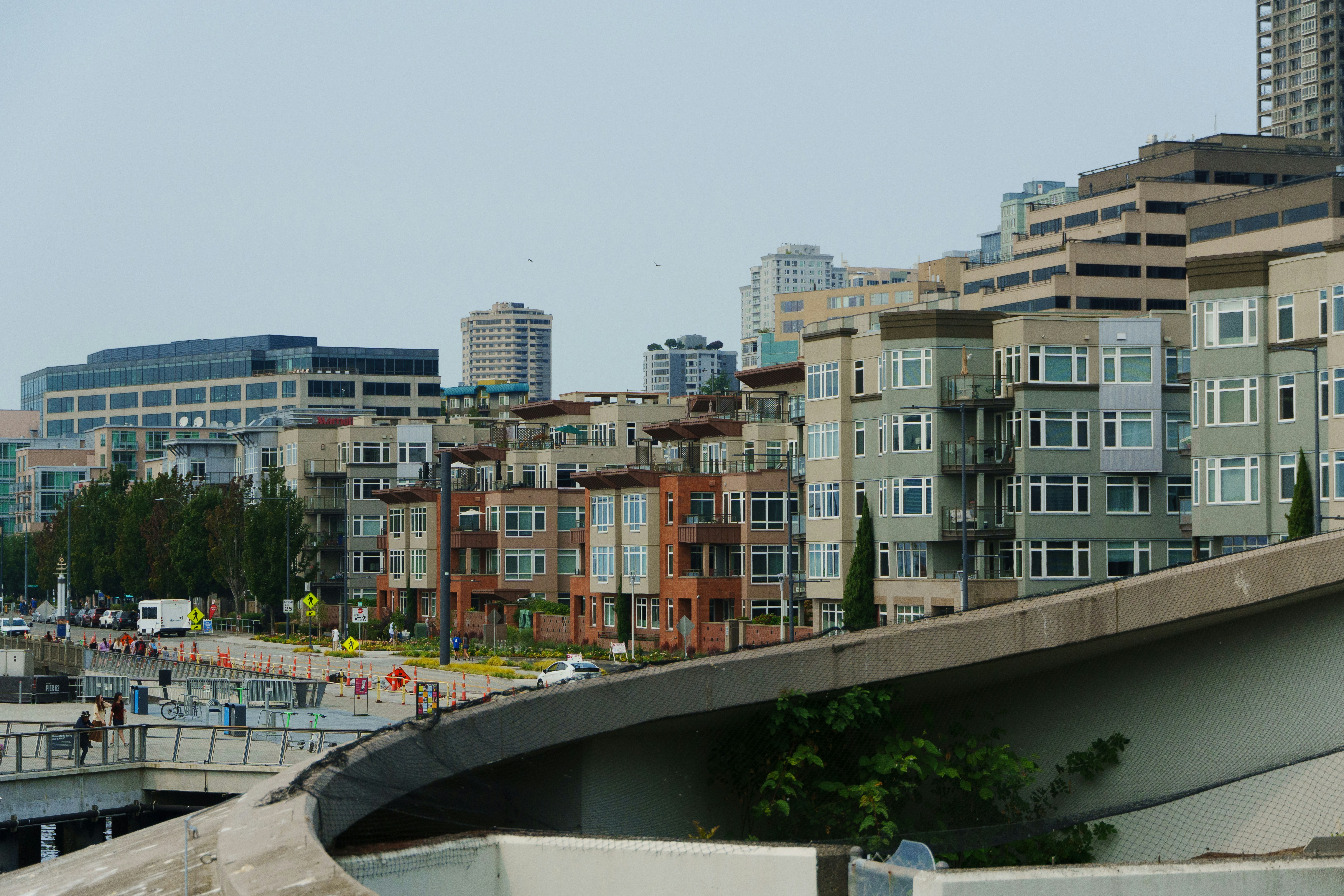 Colorful Riverside Row Beneath a Sweeping Bridge