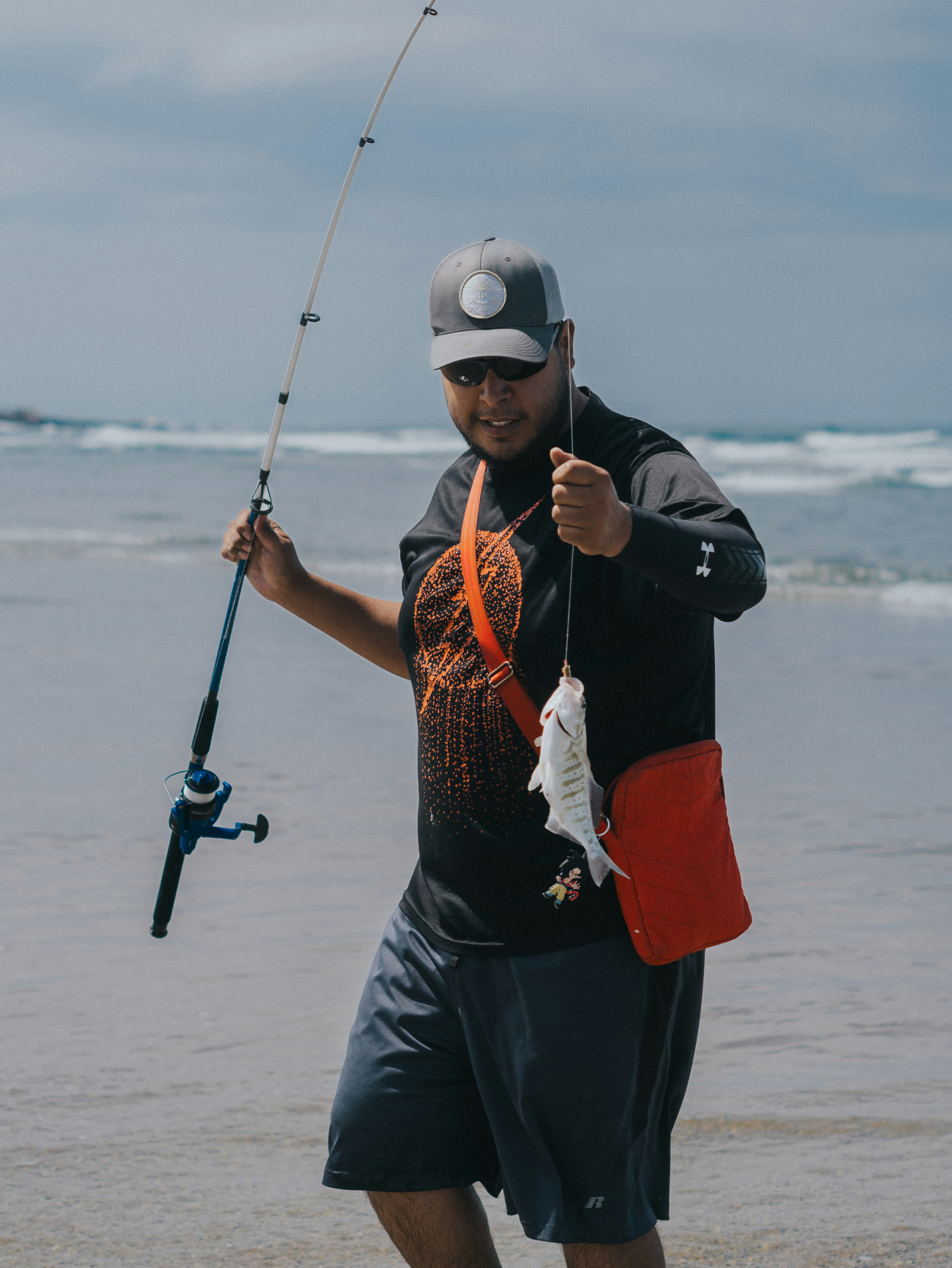 Beachfront Angler Secures a Tiny Silver Catch