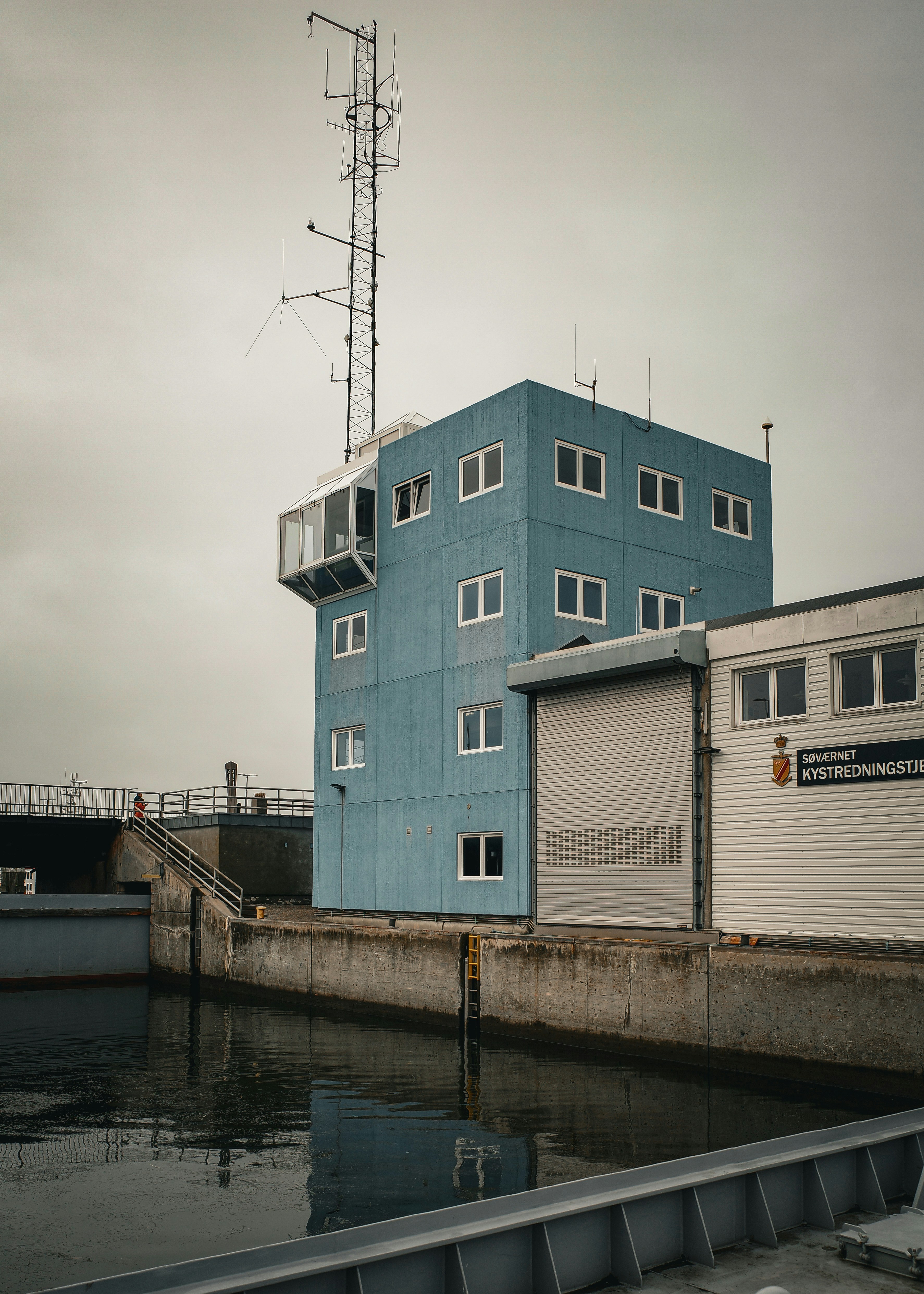Blue Harbor Watchtower Rising from Still Waters