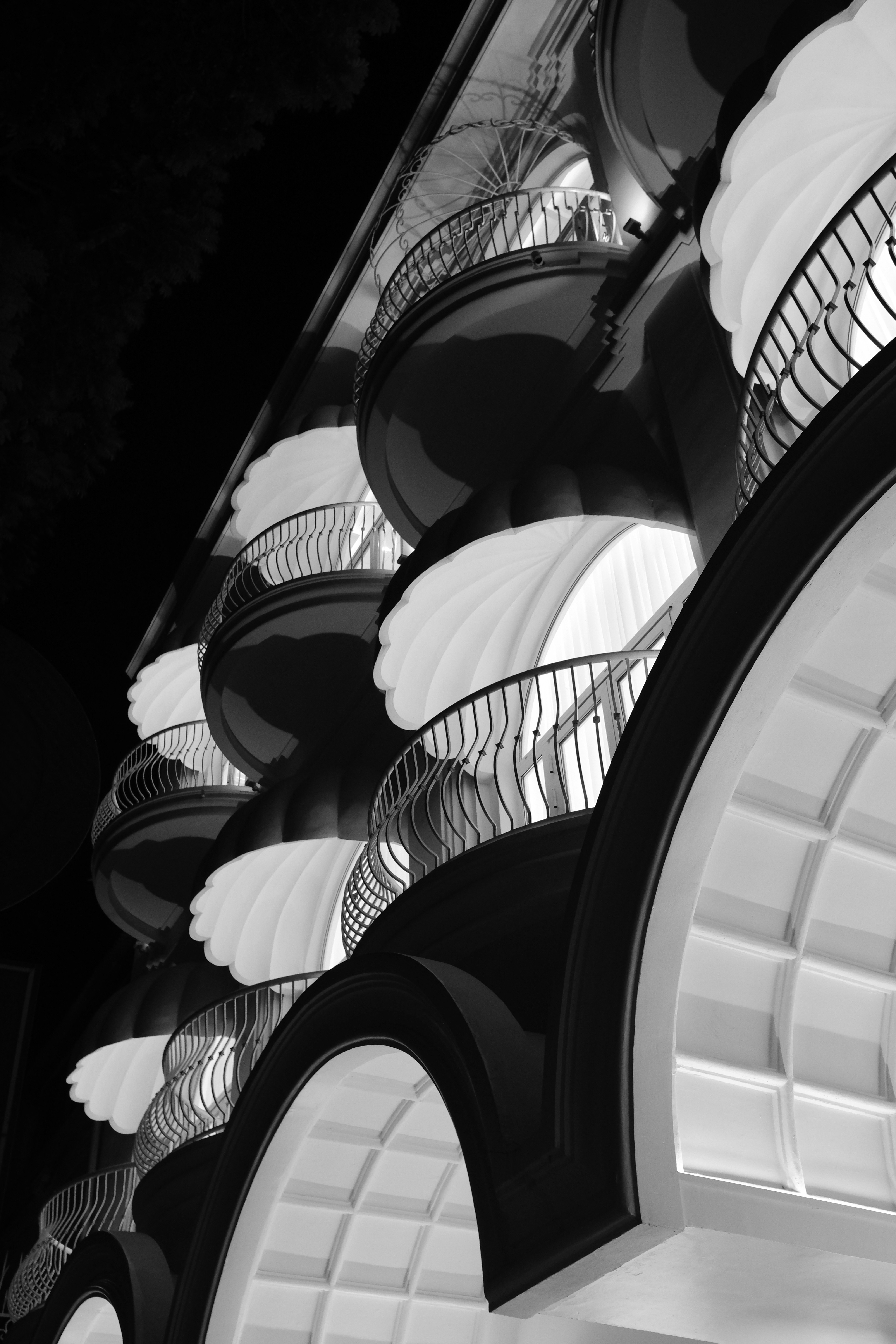Coiled Light: A Cascade of Crescent Balconies in Black and White