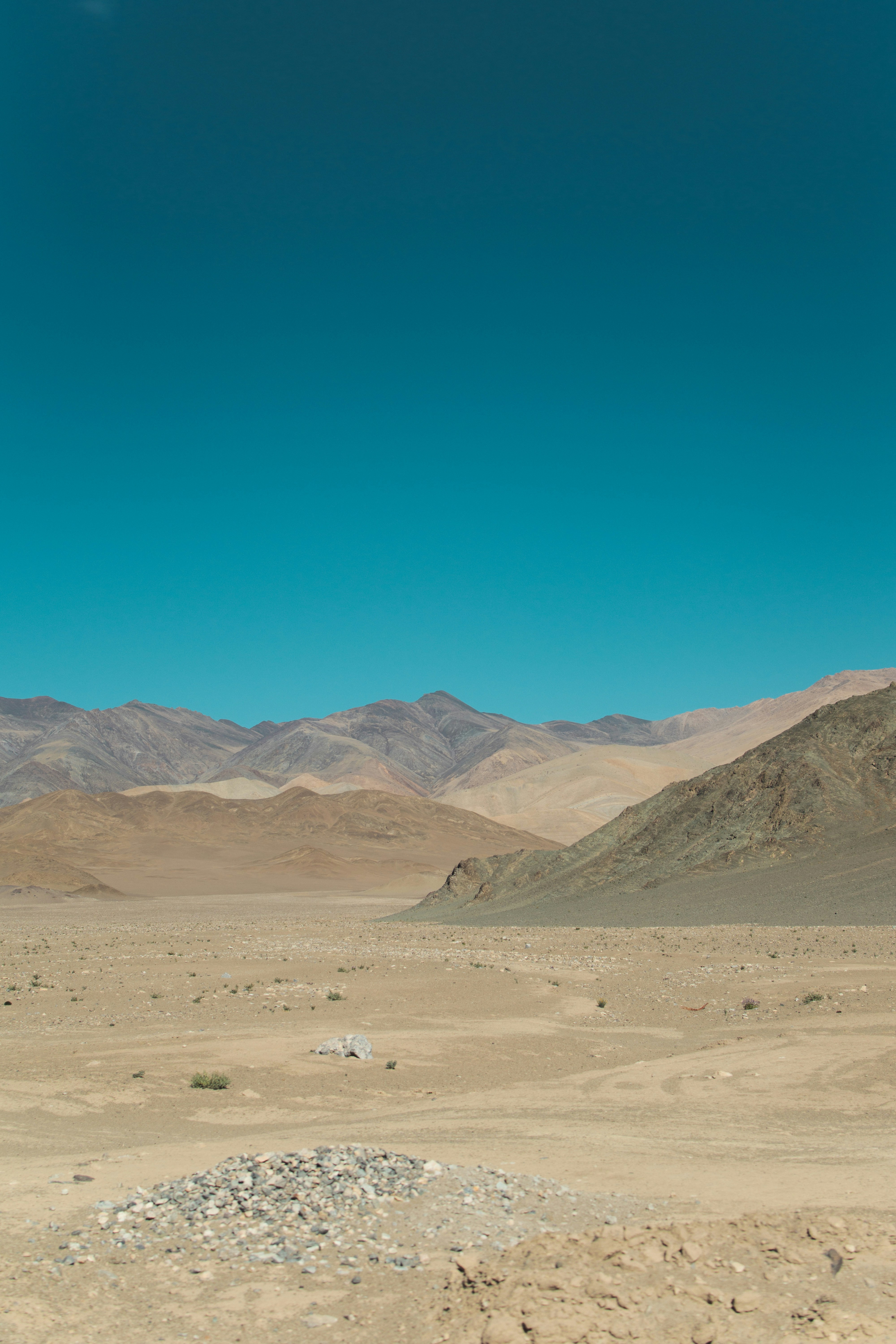 Pebble Crown in a Desert Expanse Under a Cerulean Sky