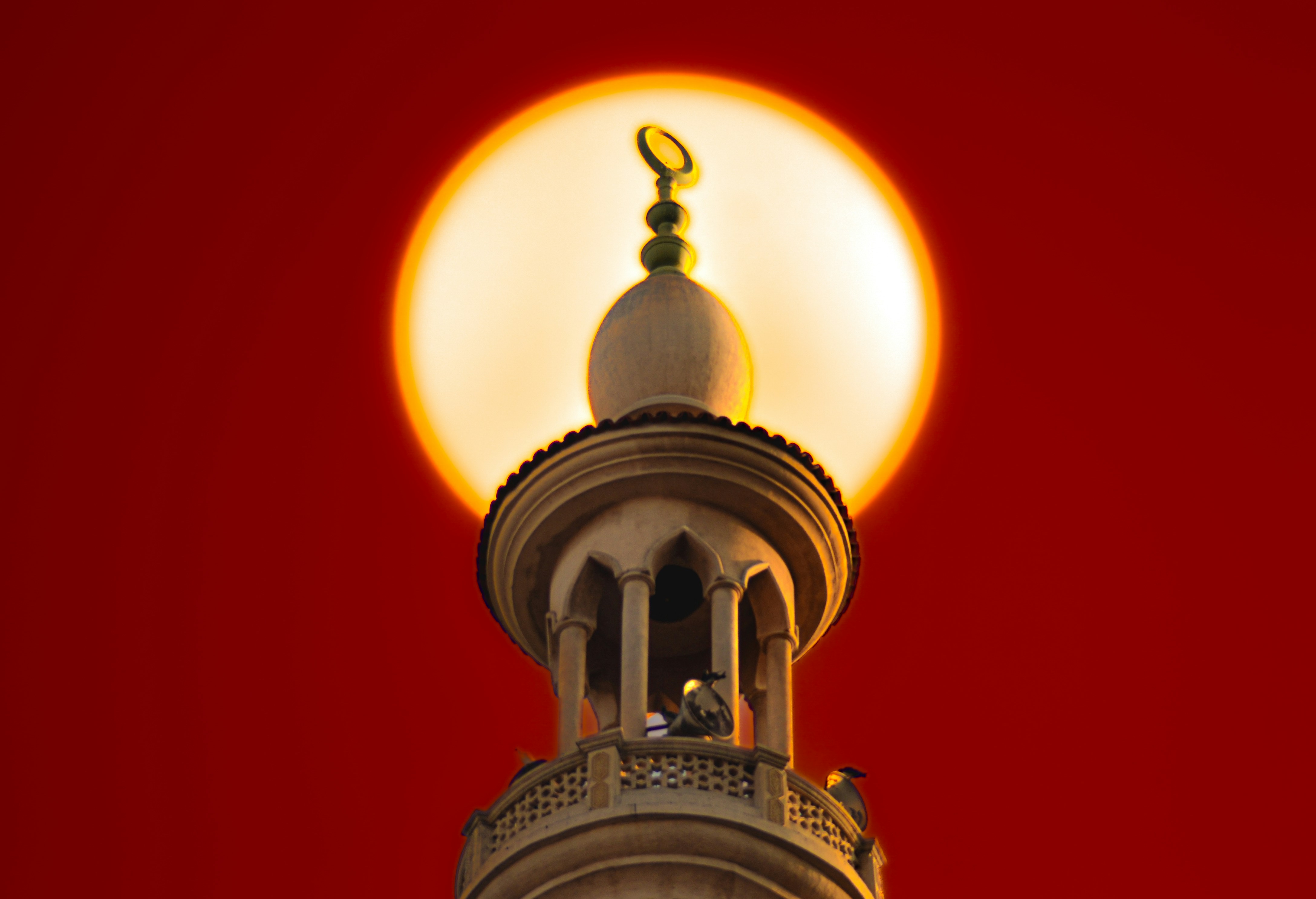 A tall clock tower with a red sky in the background photo – Free ...