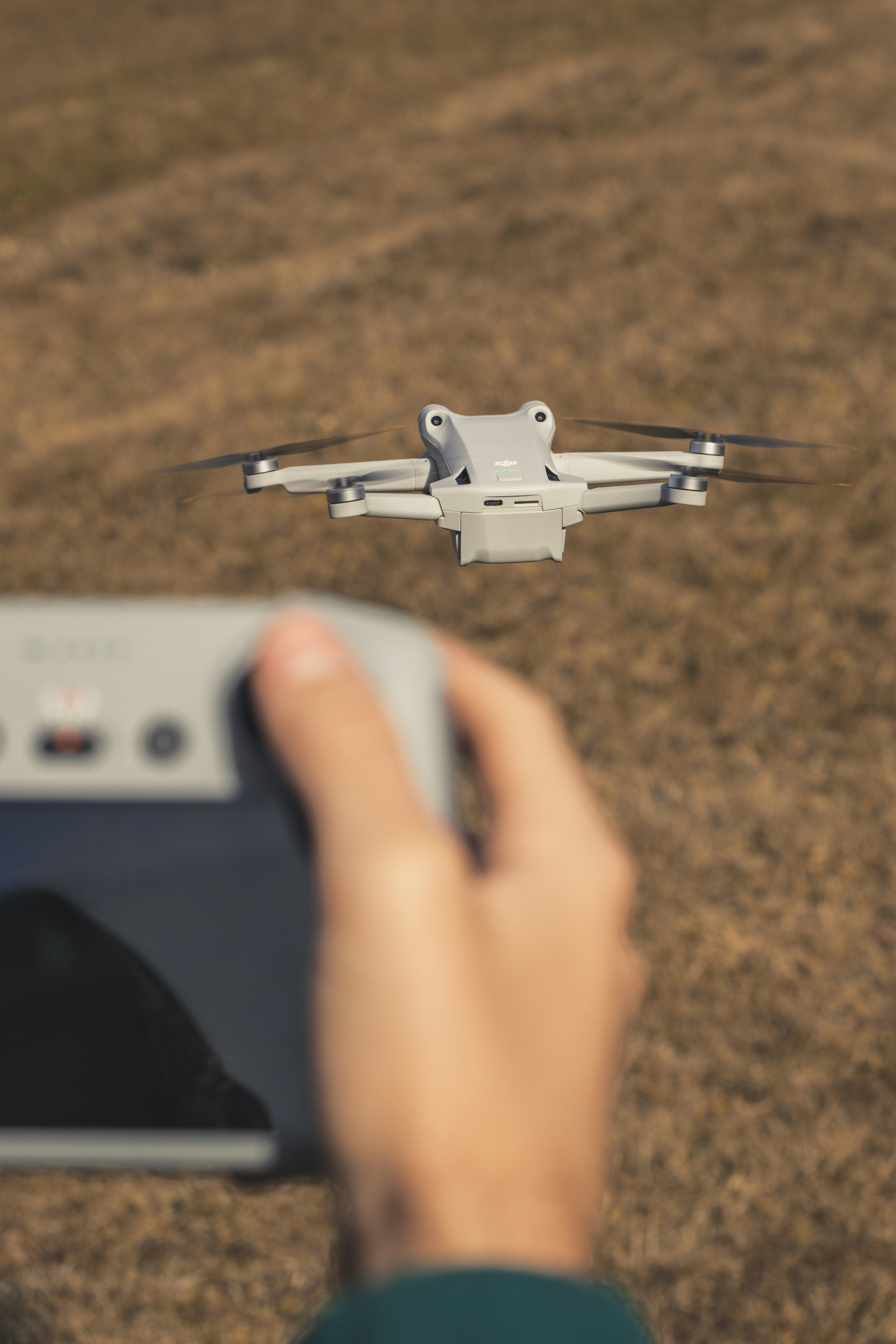 A person holding a remote control in front of a flying object photo – Free Animal Image on Unsplash
