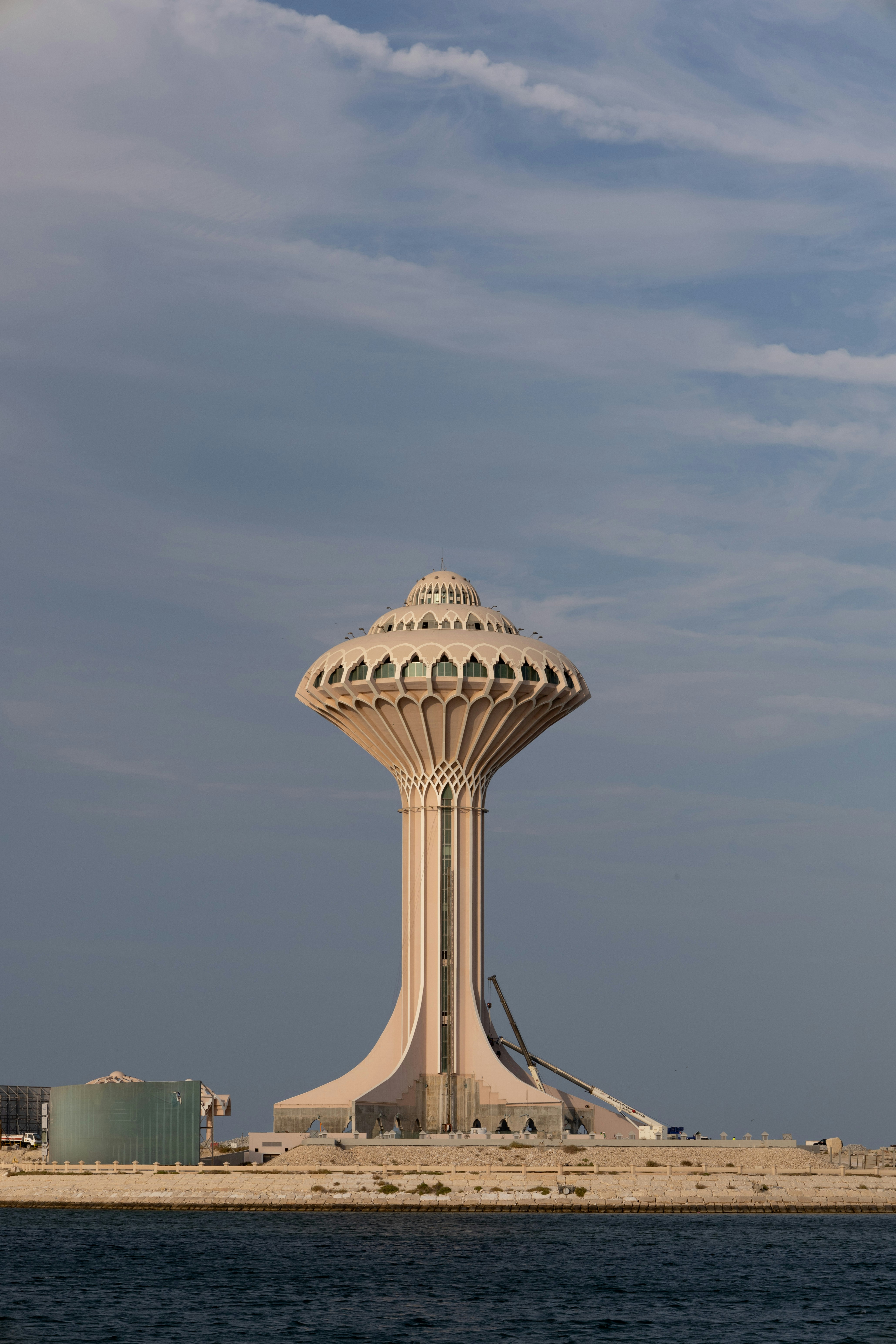 A large water tower sitting on top of a sandy beach photo – Free Khobar ...