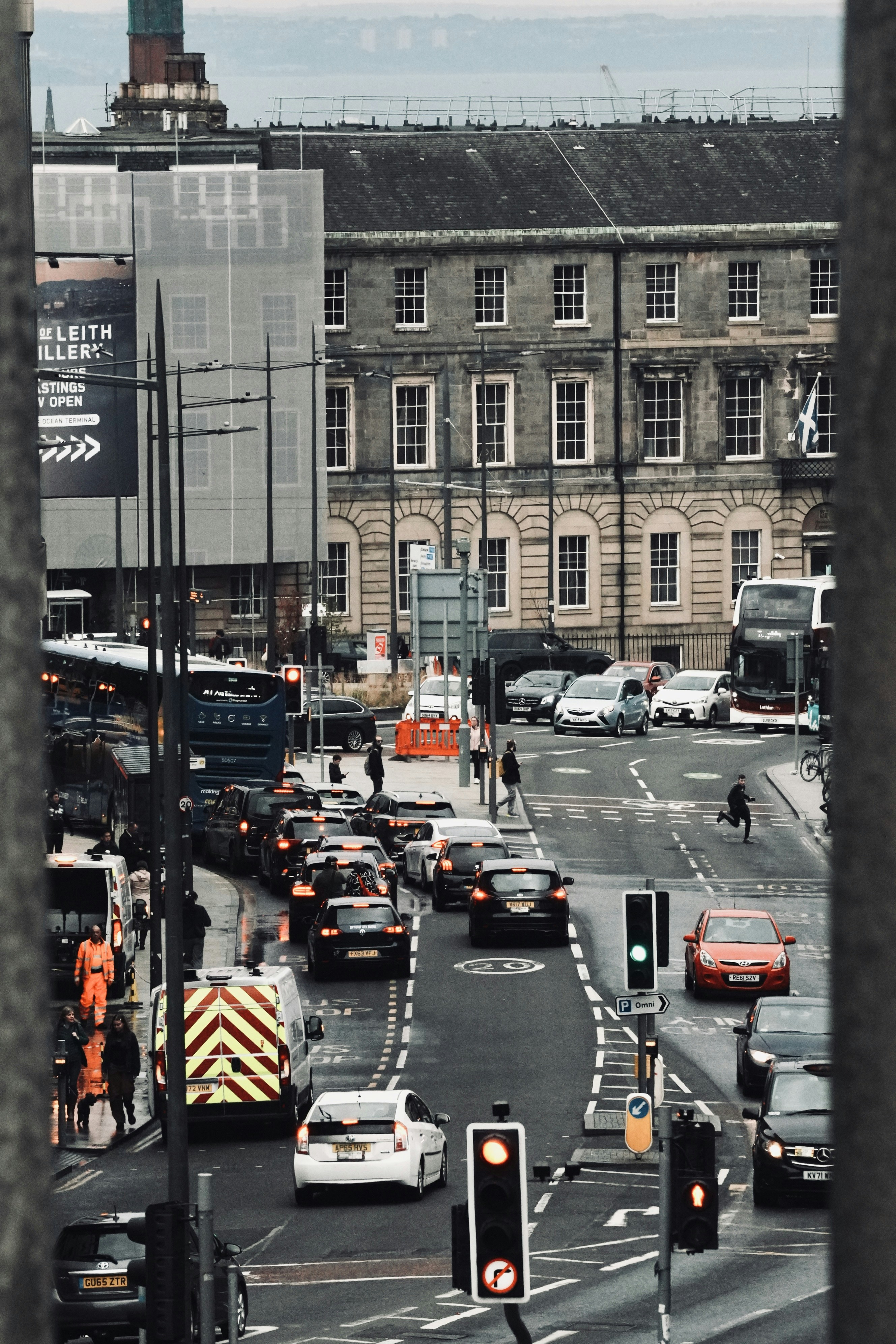 A city street filled with lots of traffic next to tall buildings photo ...
