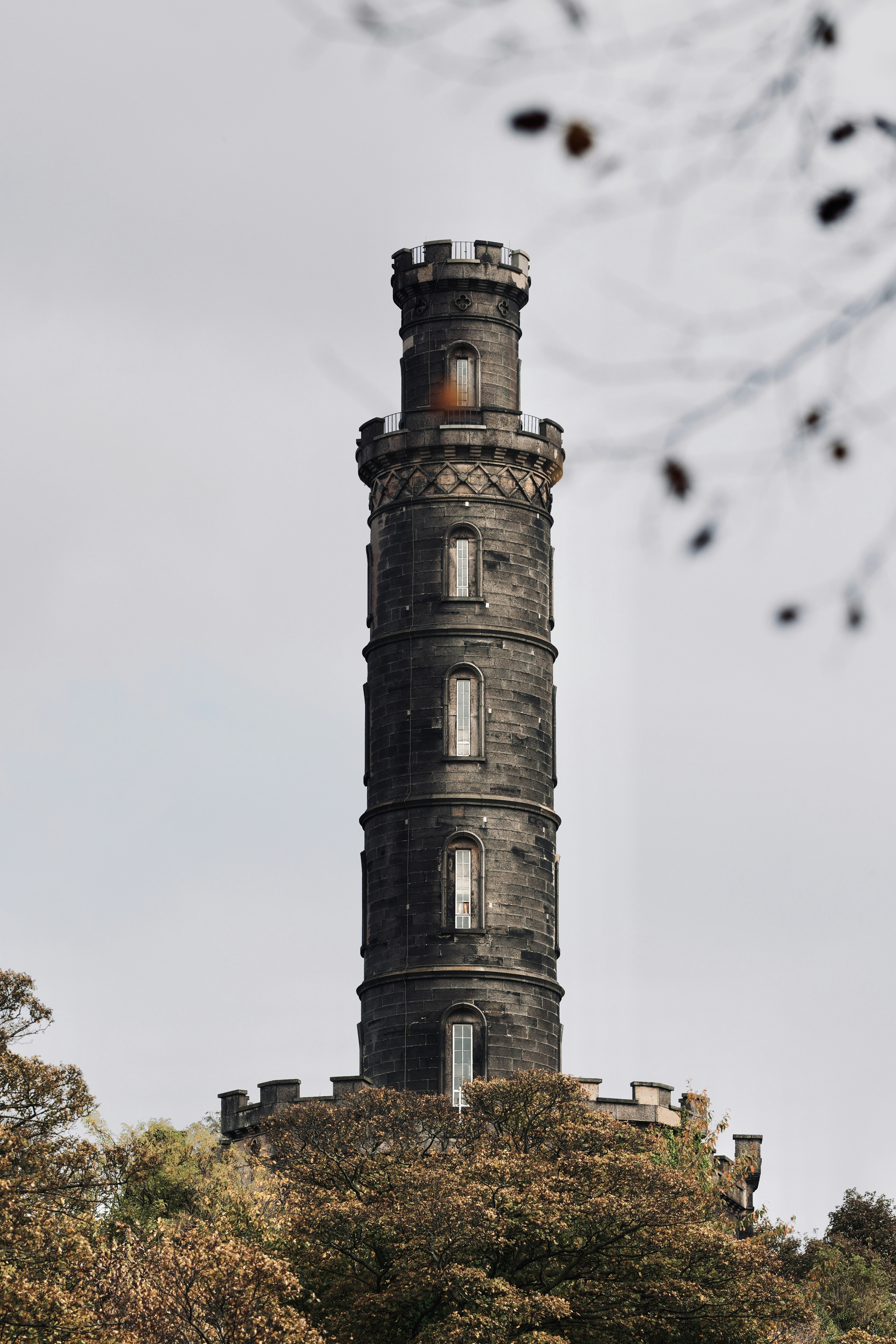 Stone Tower Rising Over Autumn Canopy