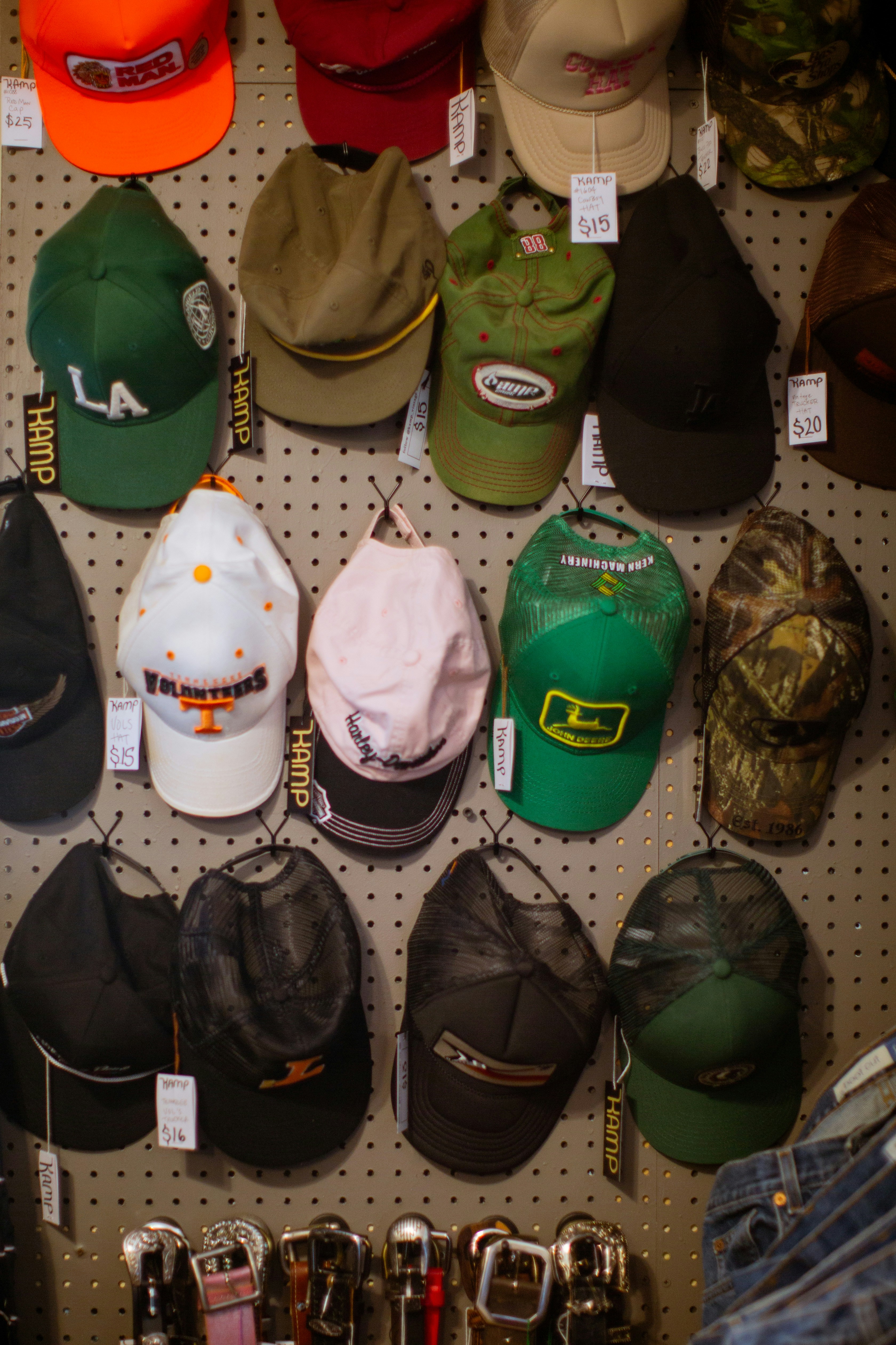 A rack of hats hanging on a wall photo – Free Bag Image on Unsplash