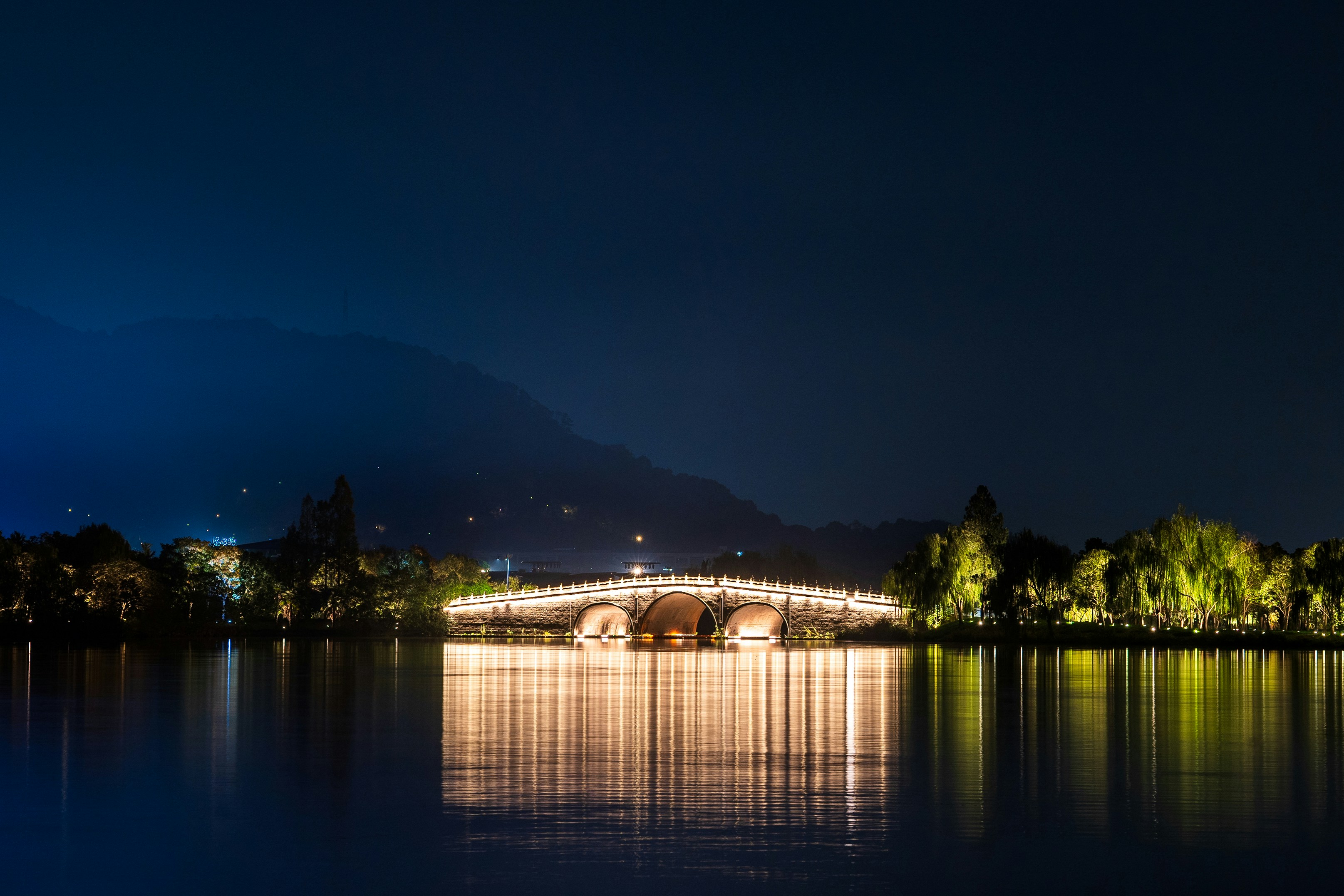 Moonlit Arc: A Bridge's Golden Reflection