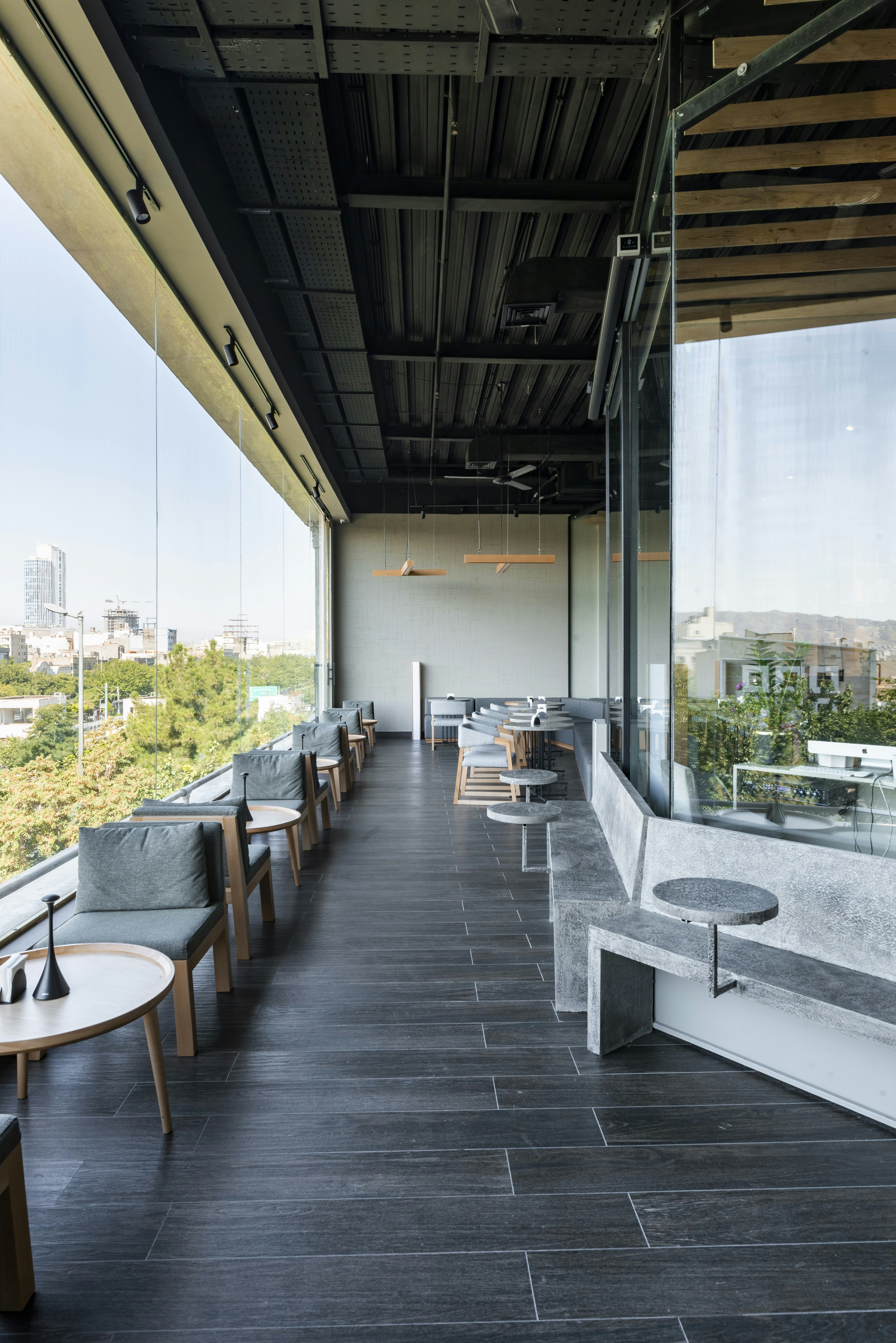 A balcony with benches and tables and a view of the city photo – Free ...
