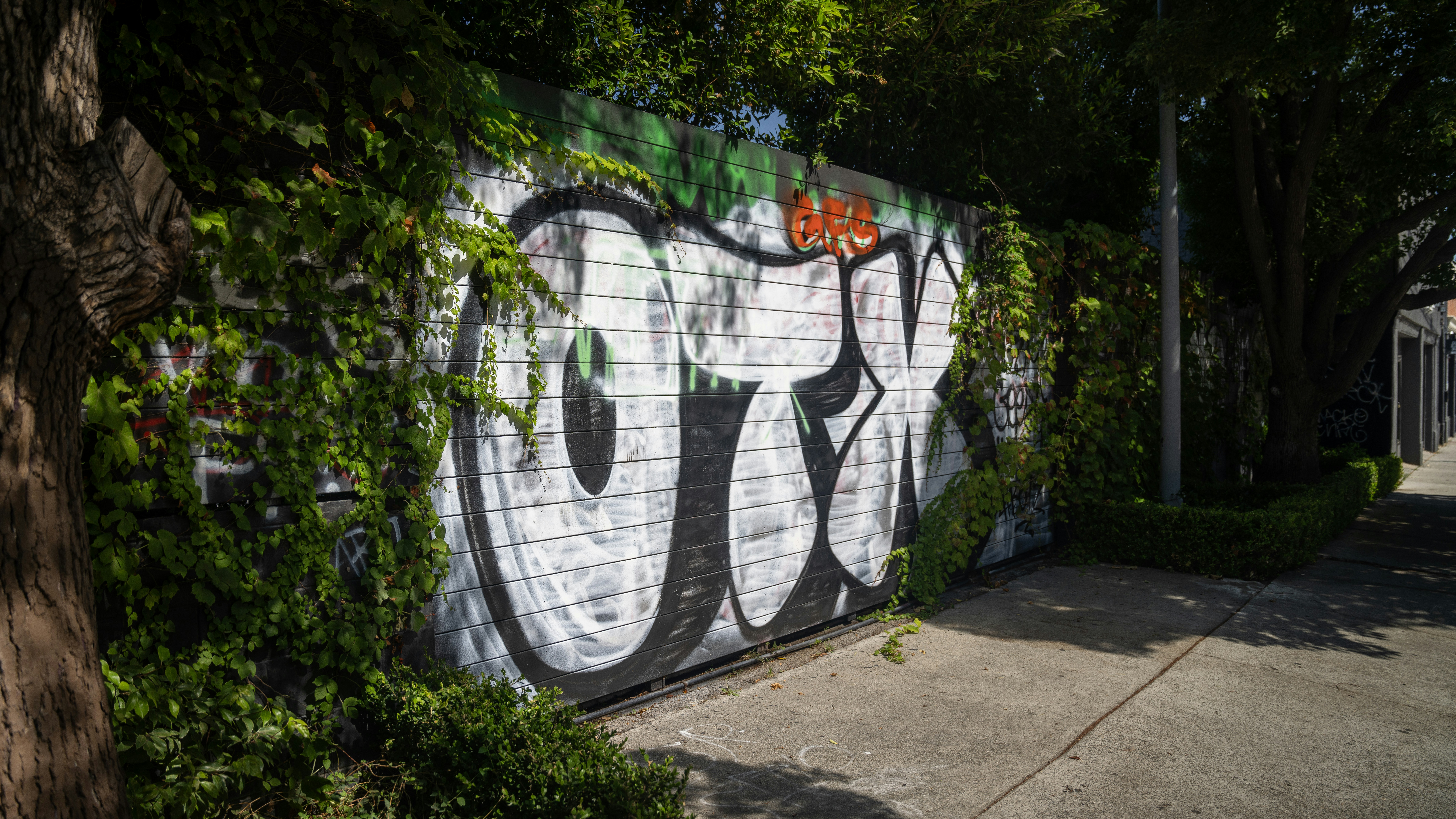 A wall covered in graffiti on a sidewalk photo – Free Los angeles Image ...