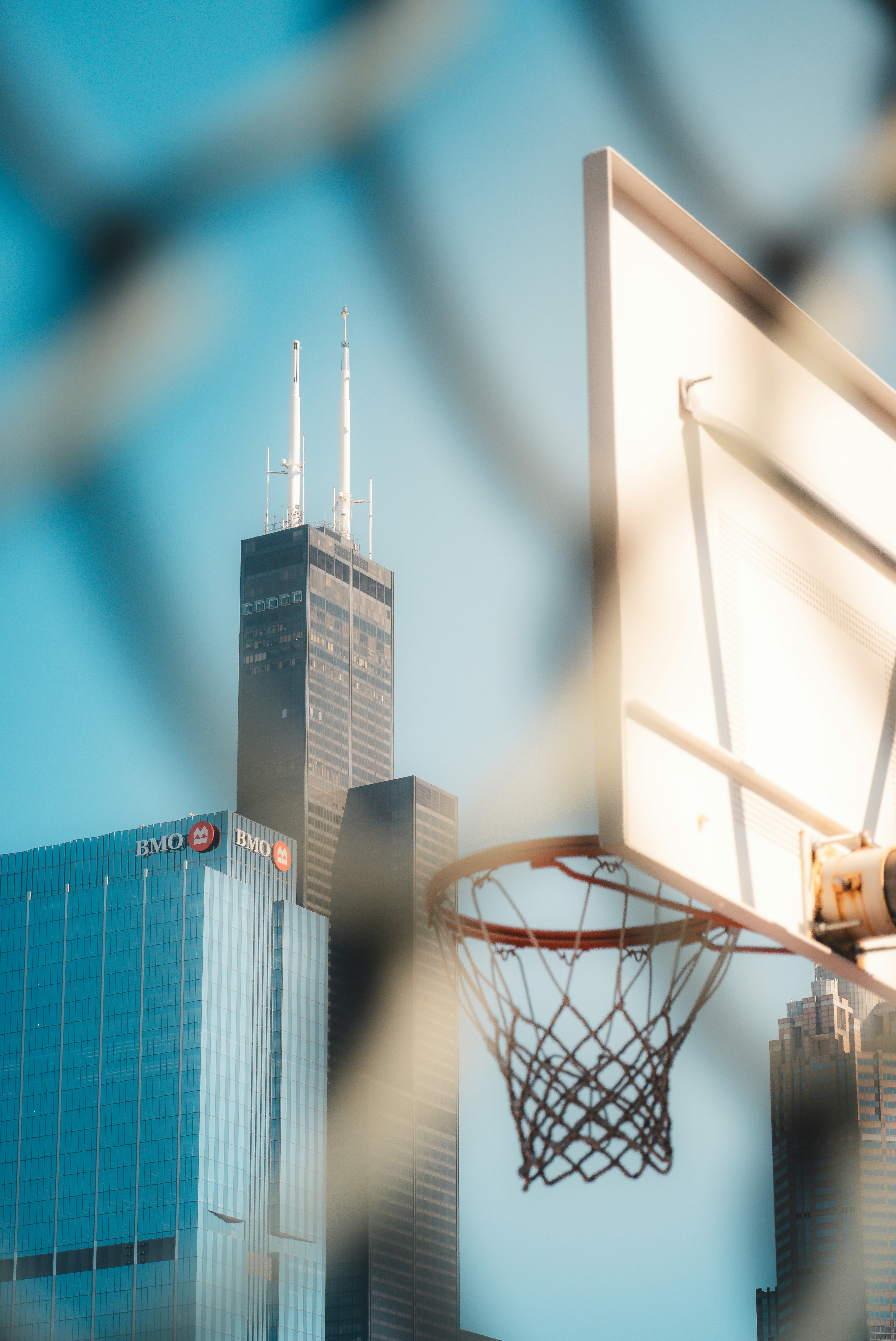 A view of a basketball hoop through a fence photo – Free Chicago Image ...