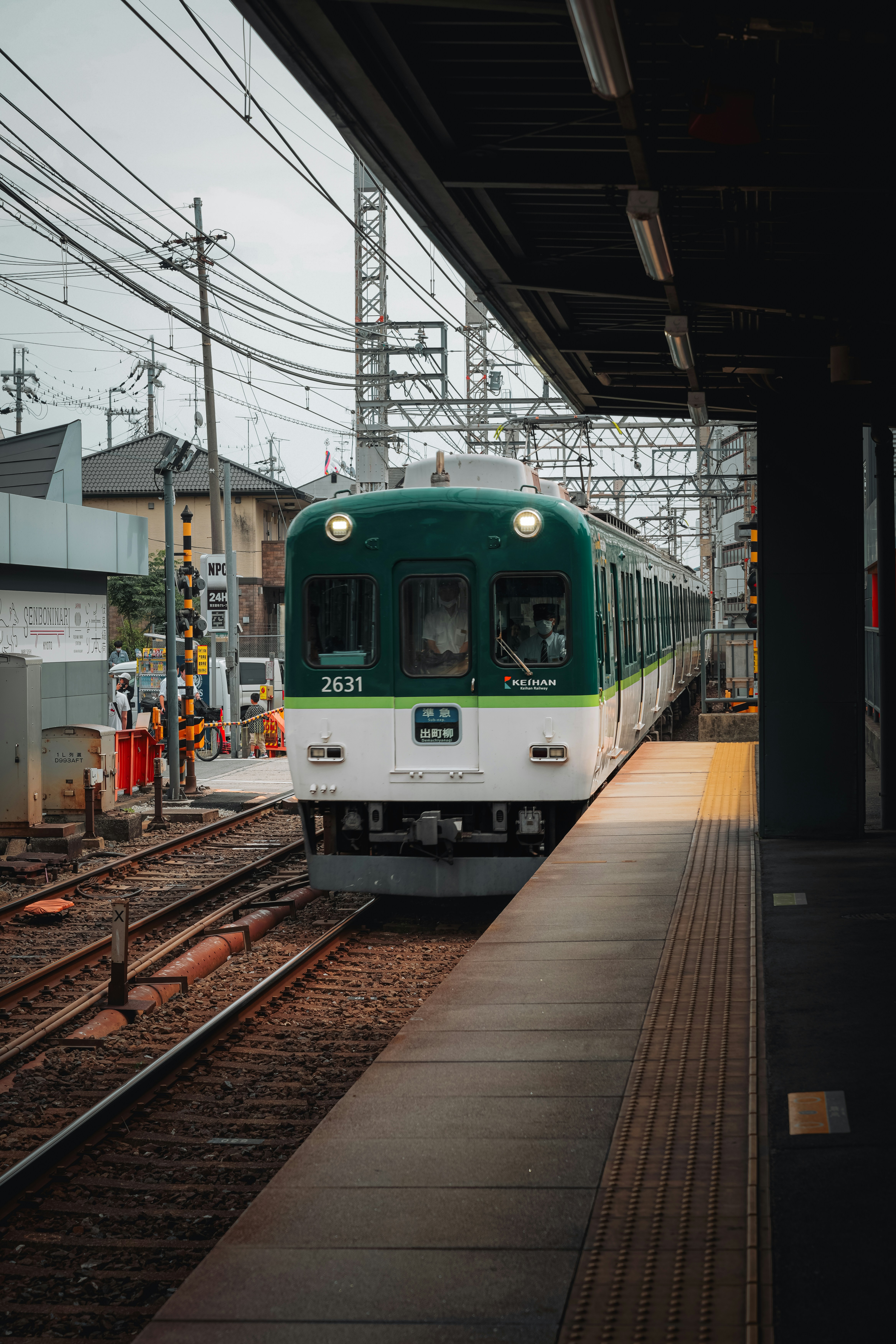 Front-Center Green Commuter: Train at a Quiet Platform
