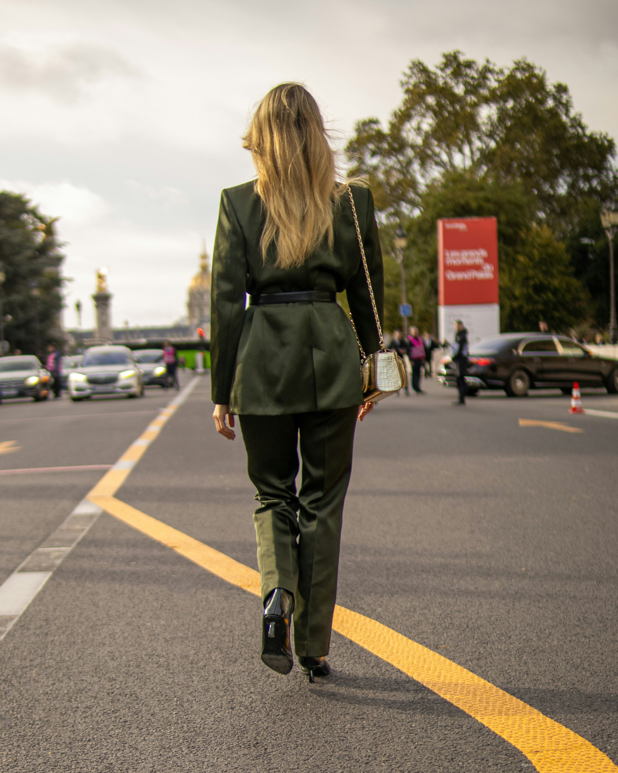 Green Tailored Stride: Back-View on a City Avenue
