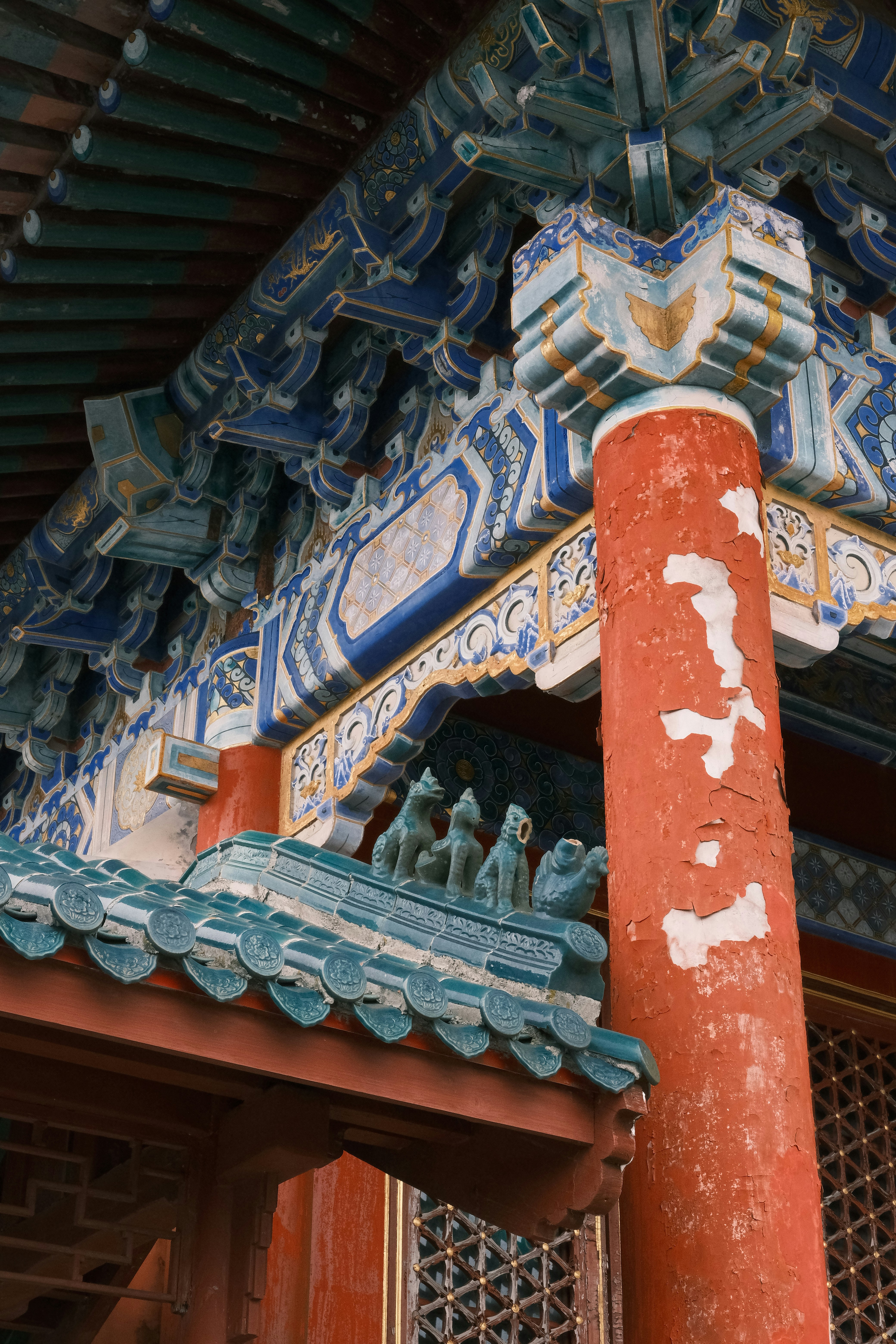 Crimson Column Framed by Jade-Blue Carvings in a Timeless Chinese Pavilion
