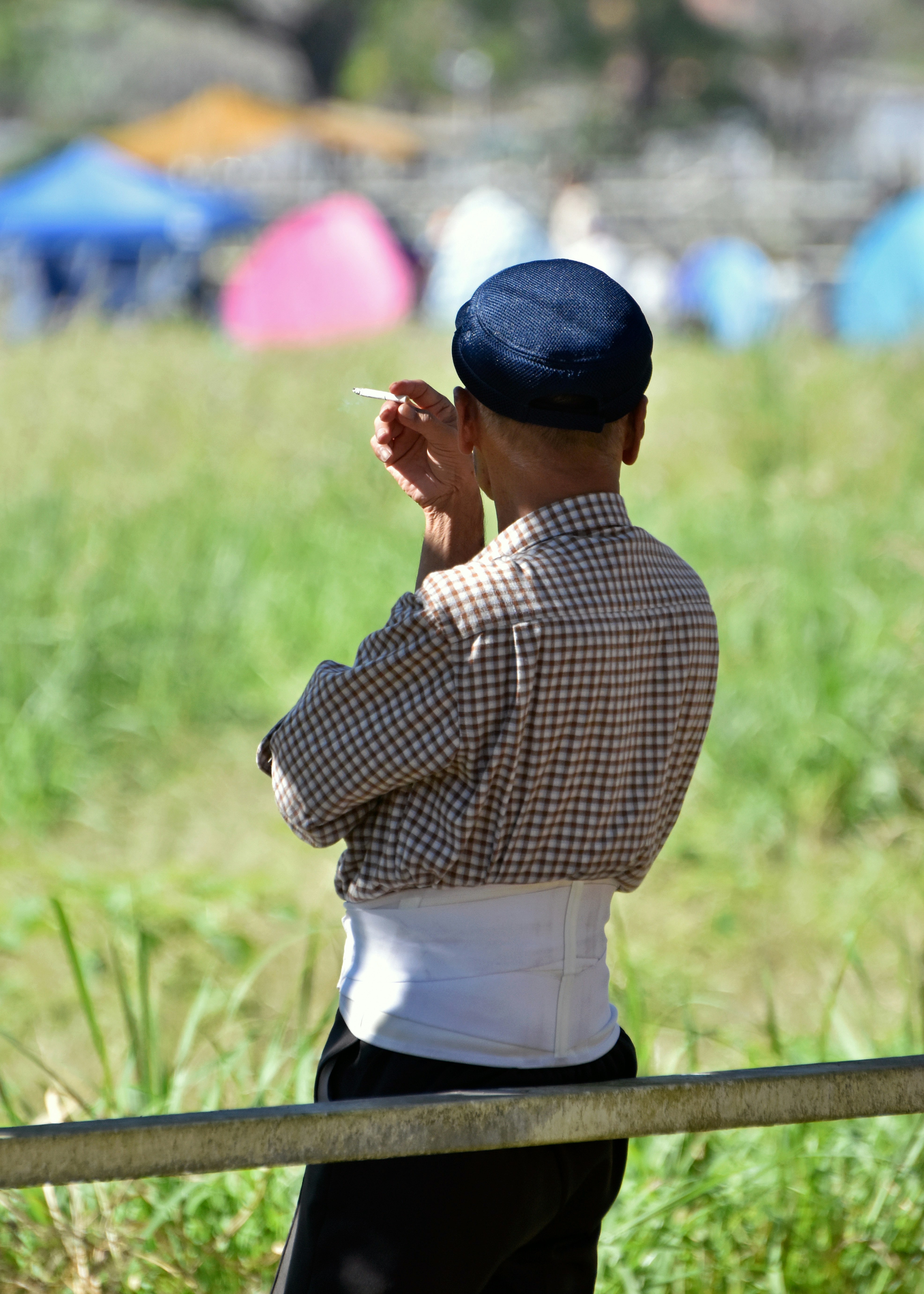 Checked Shirt, White Sash: A Quiet Gesture in a Festival Field
