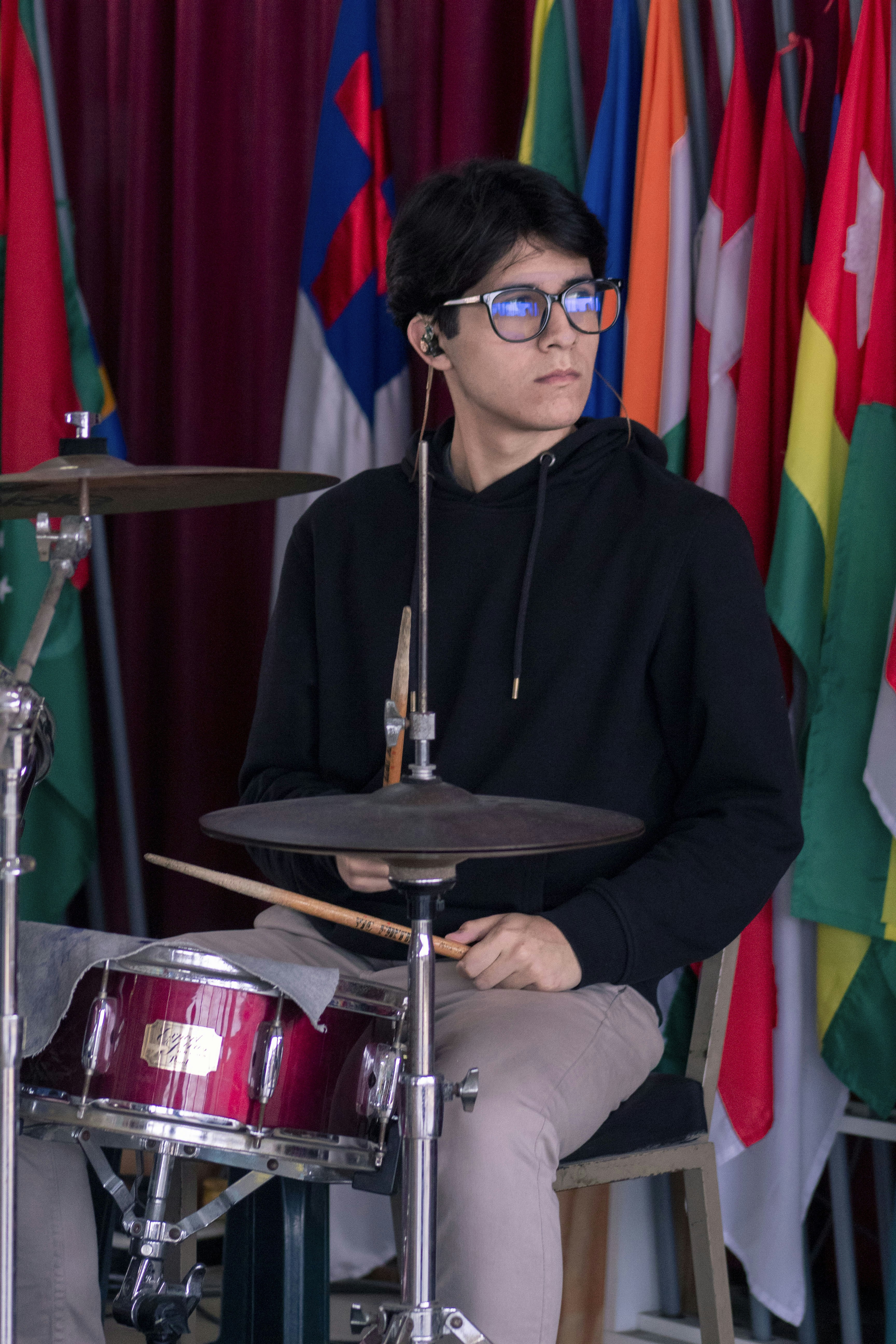 A man sitting in front of a drum set photo – Free Human Image on Unsplash