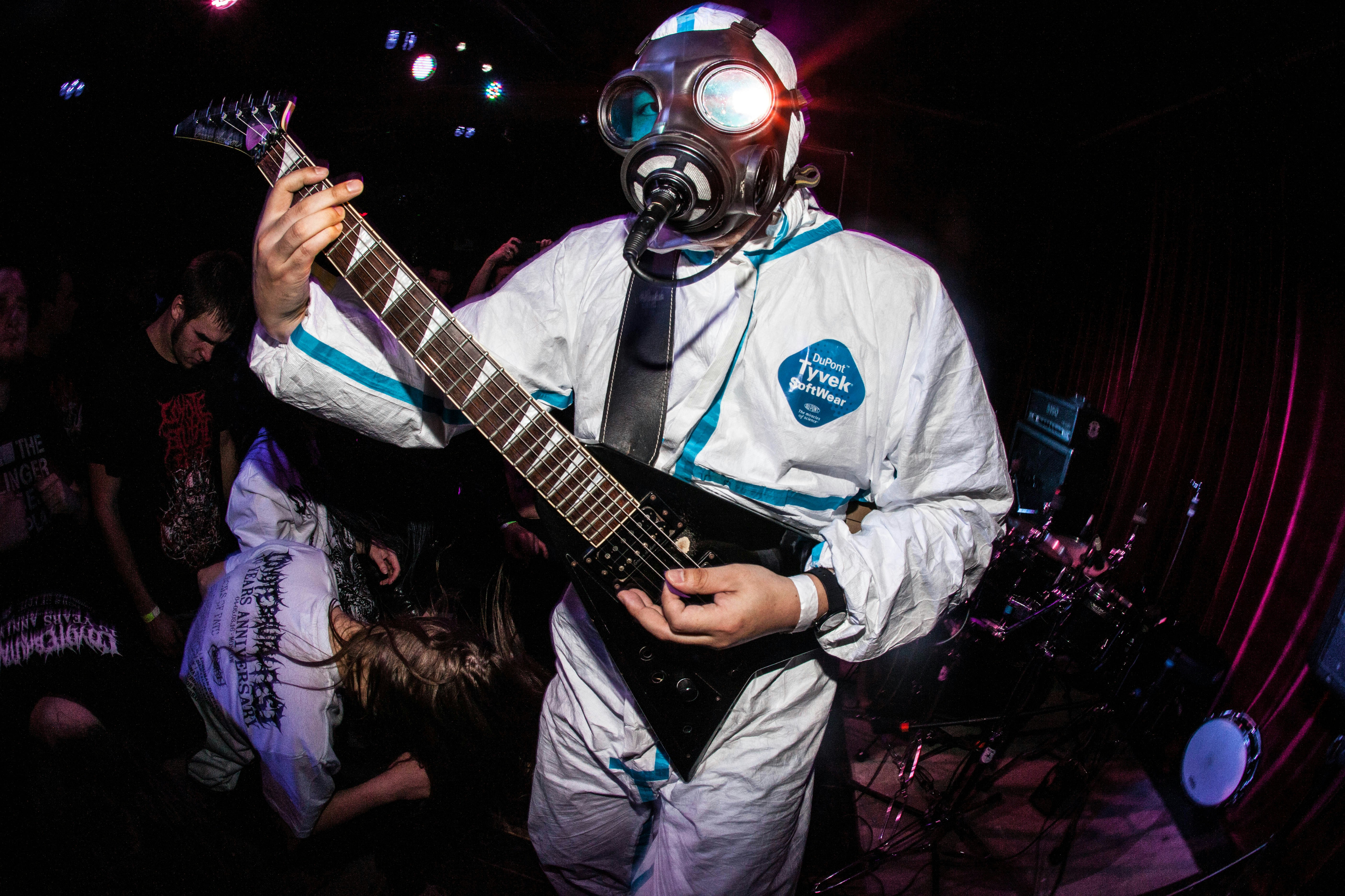 A man in a gas mask playing a guitar photo – Free Guitar Image on Unsplash