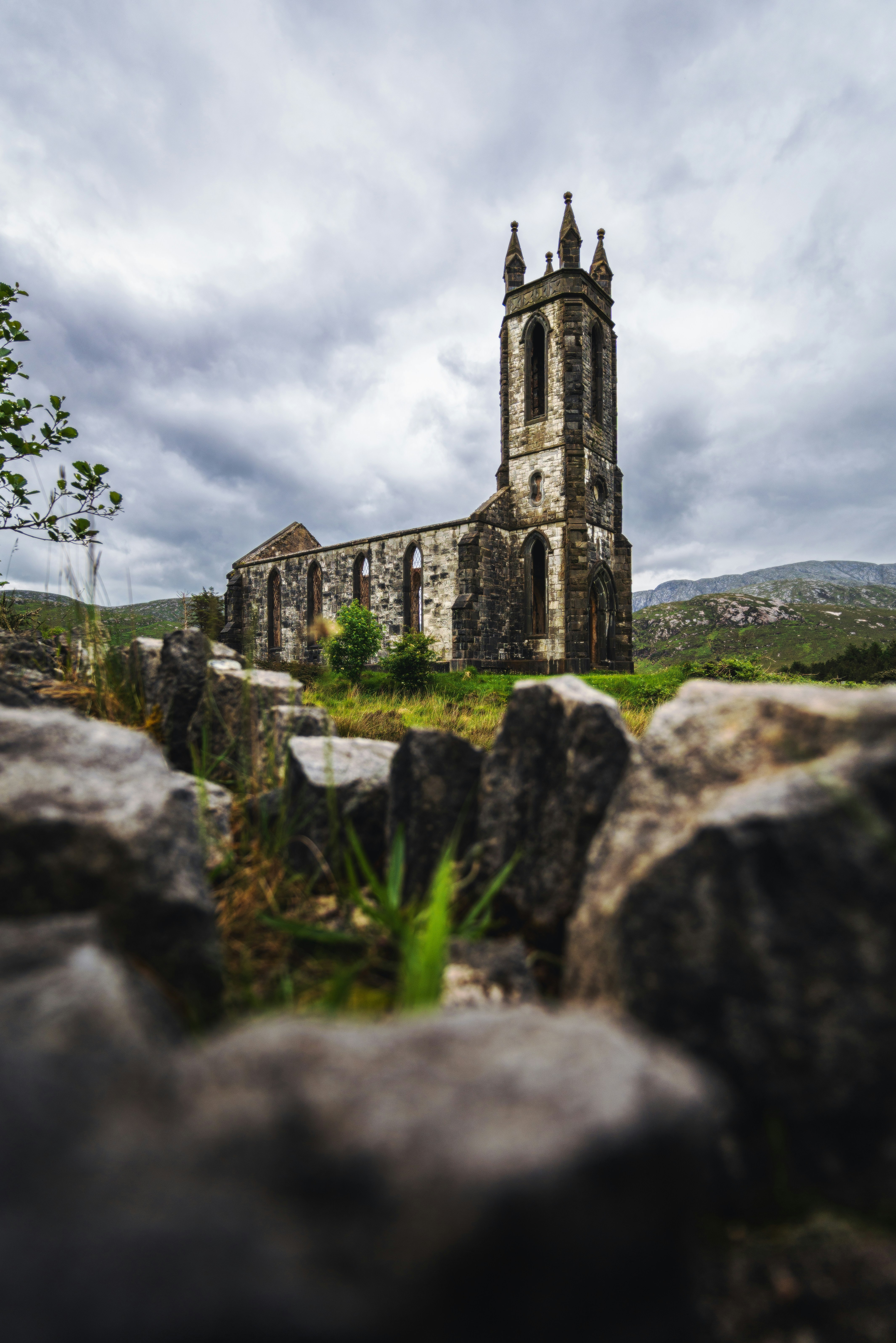 Towering Stone Chapel Against a Moody Highland Sky