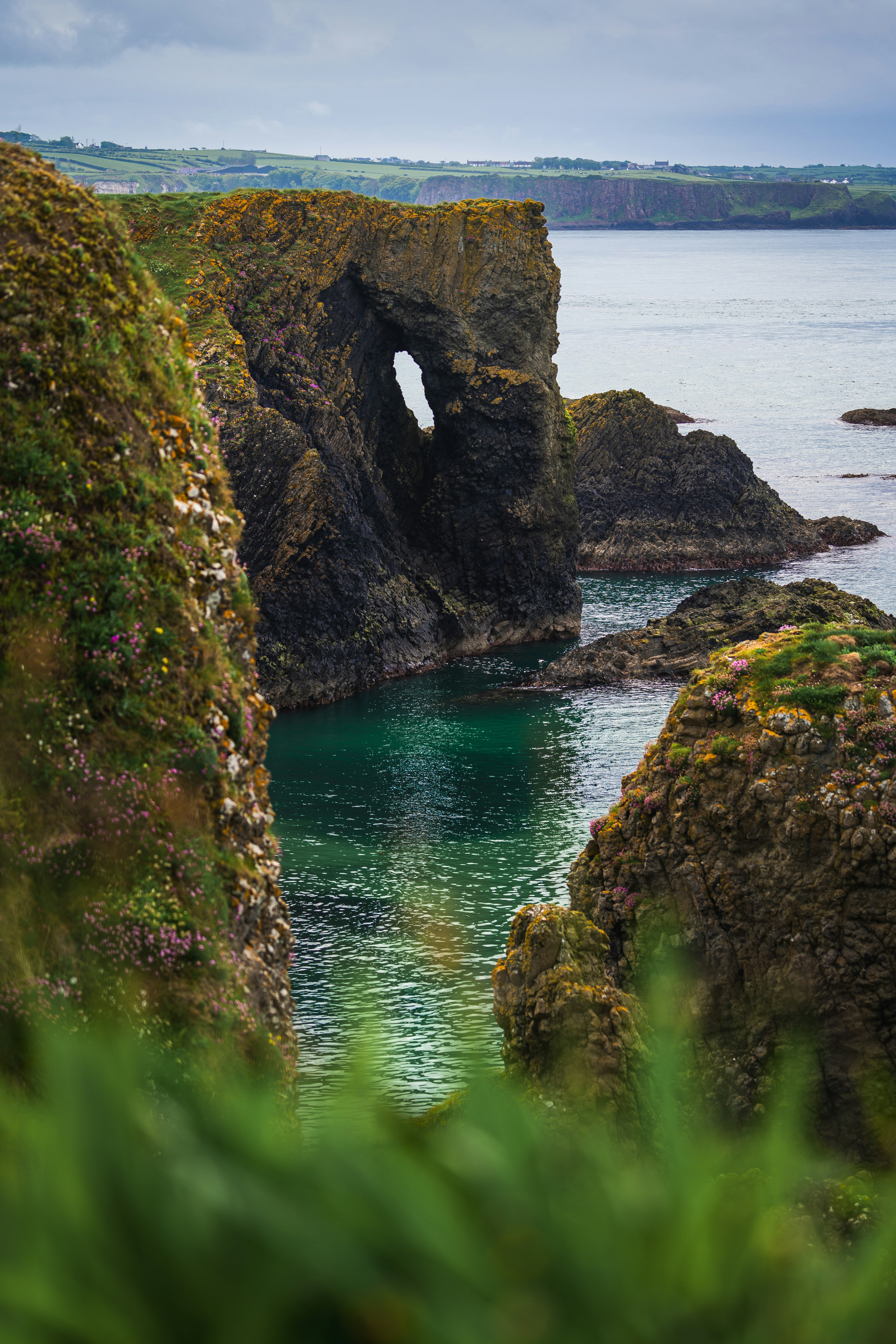 Emerald Arch: Mossy Cliffs Framing a Turquoise Seascape