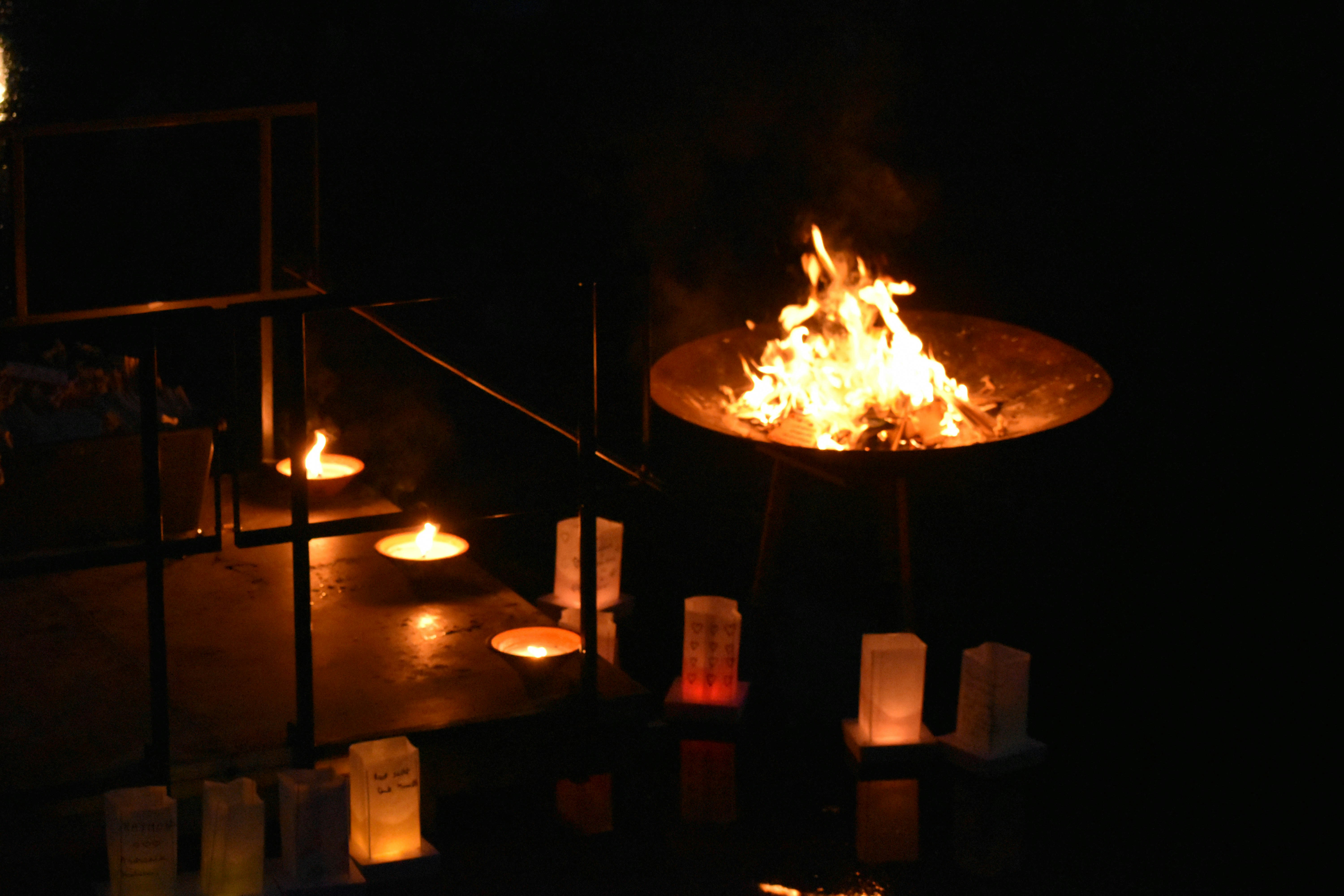 A fire pit surrounded by candles in the dark photo – Free Hasselt Image ...