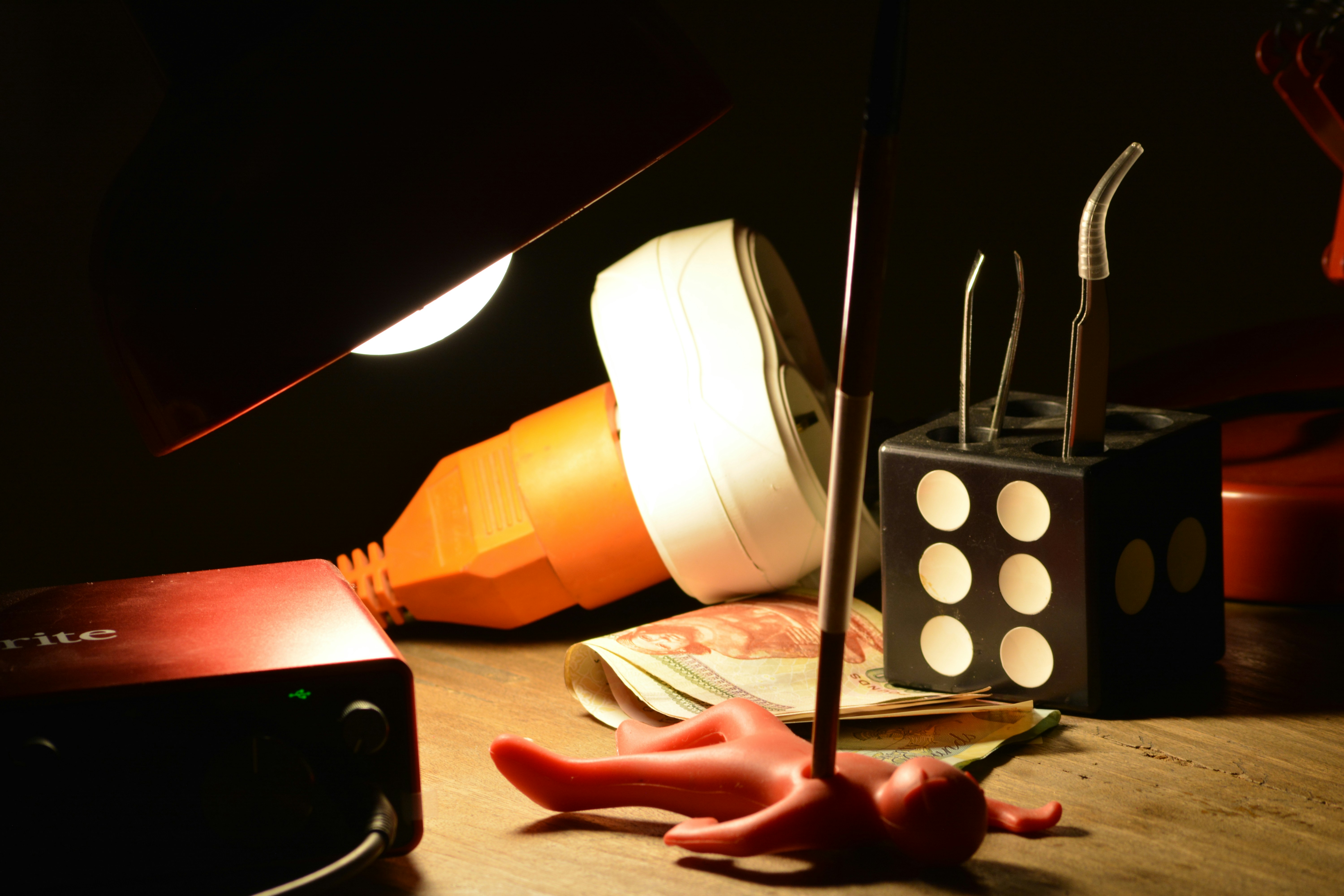Pink Curve in Warm Light: A Curious Desk Still Life with Tools