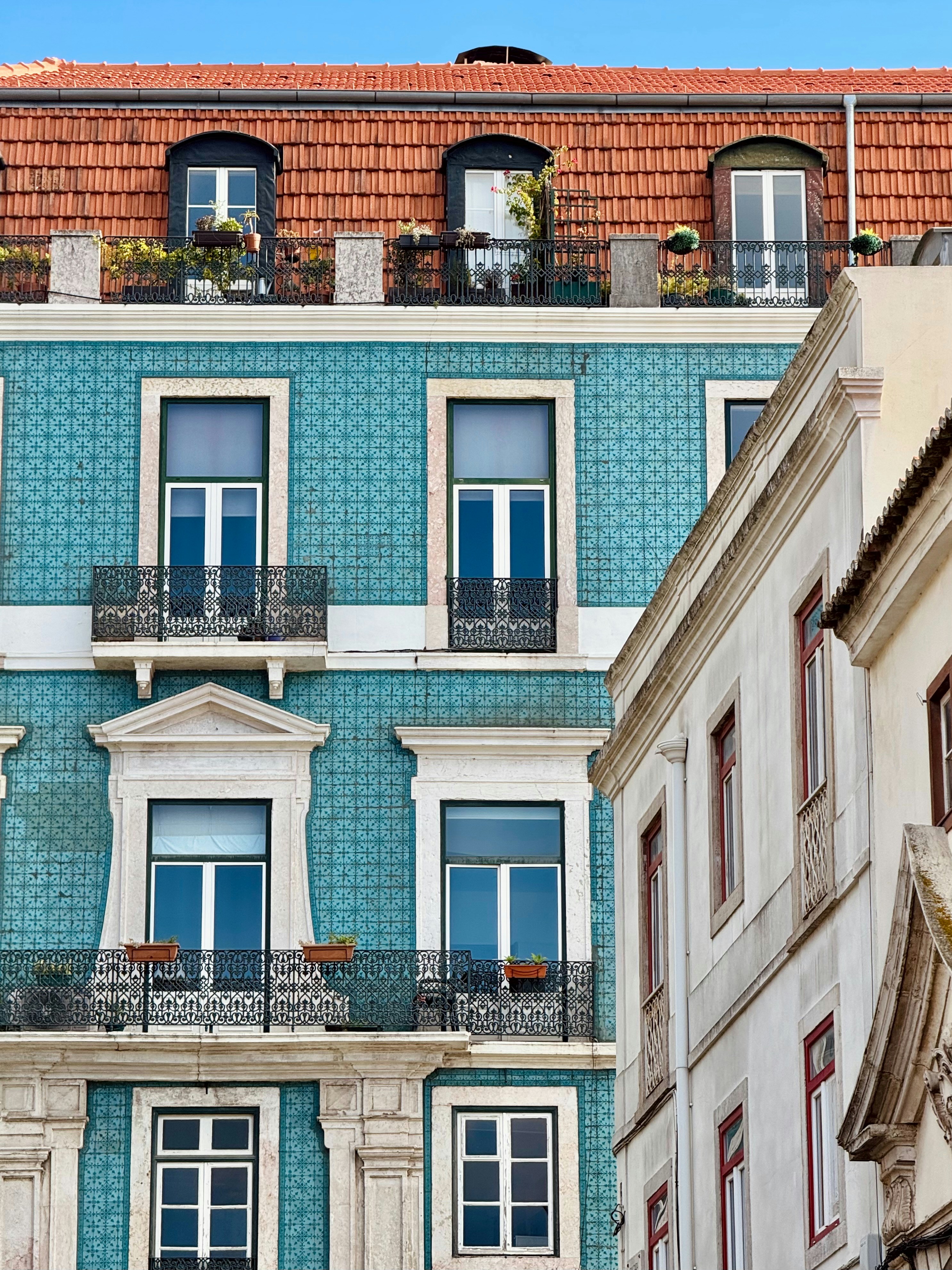 Teal Facade, White Cornices: A Lisbon-Style Row of Tiles and Balconies