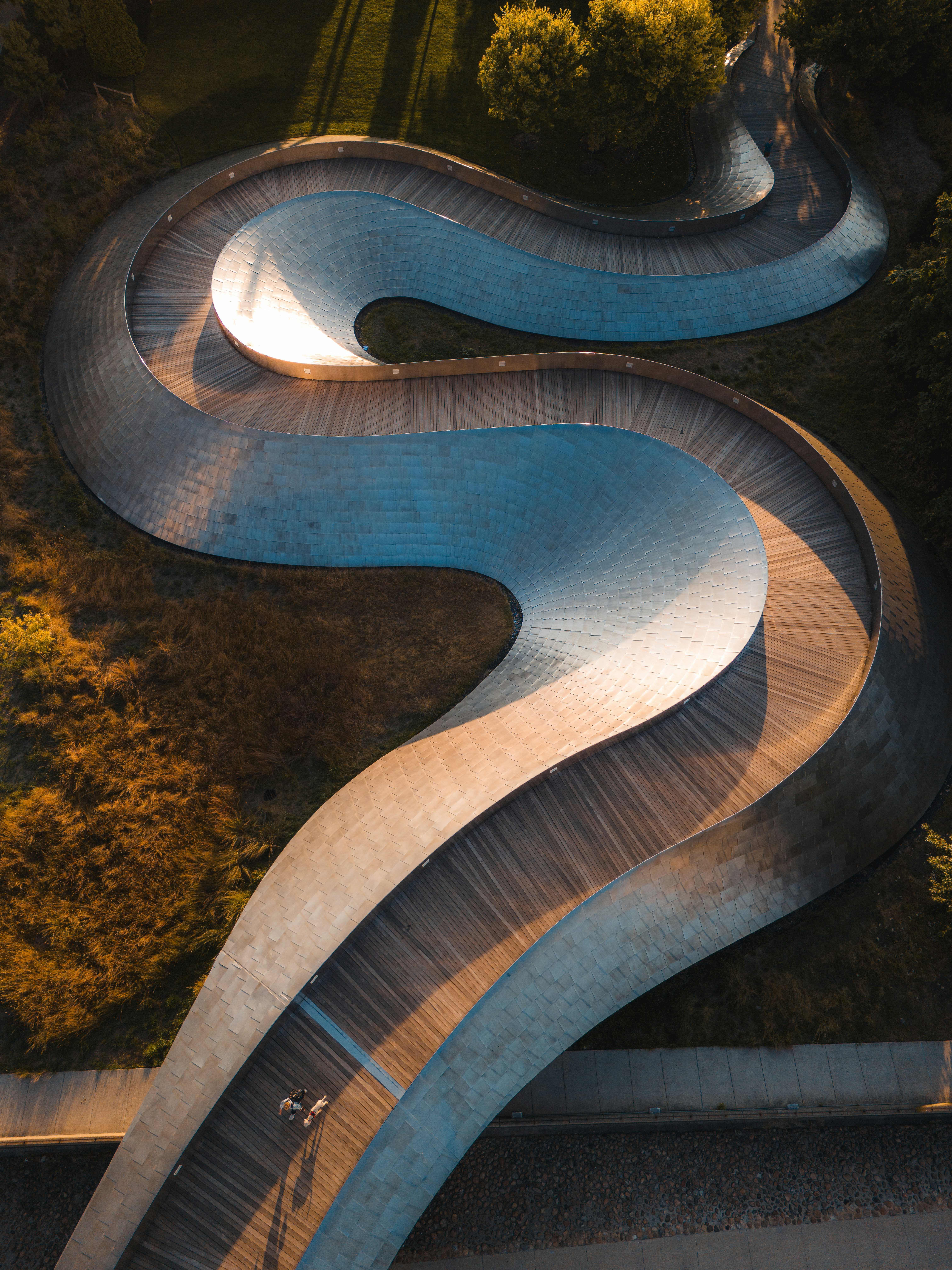 An aerial view of a curved road at night photo – Free Road Image on ...