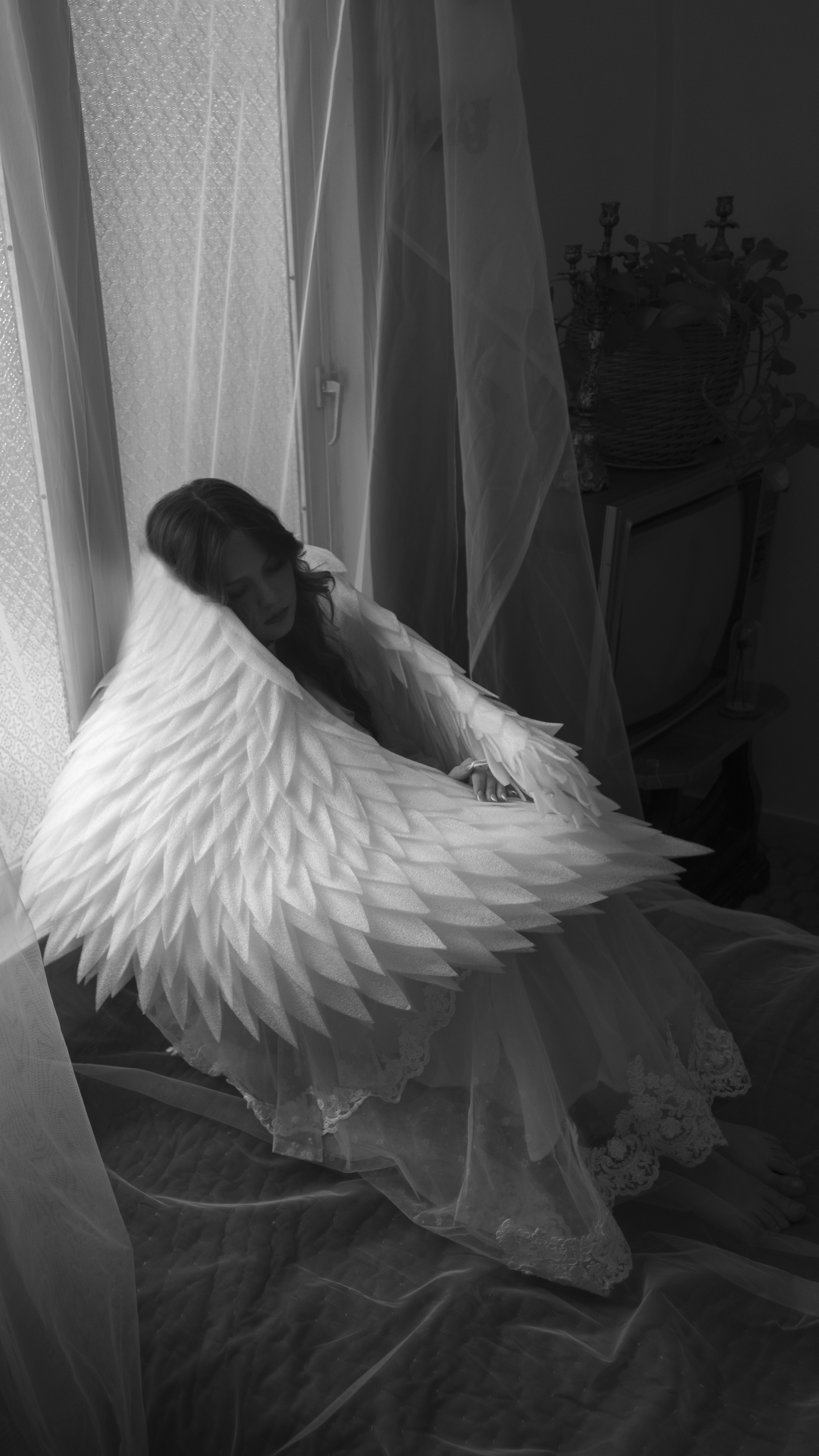 A black and white photo of an angel laying on a bed photo – Free ...