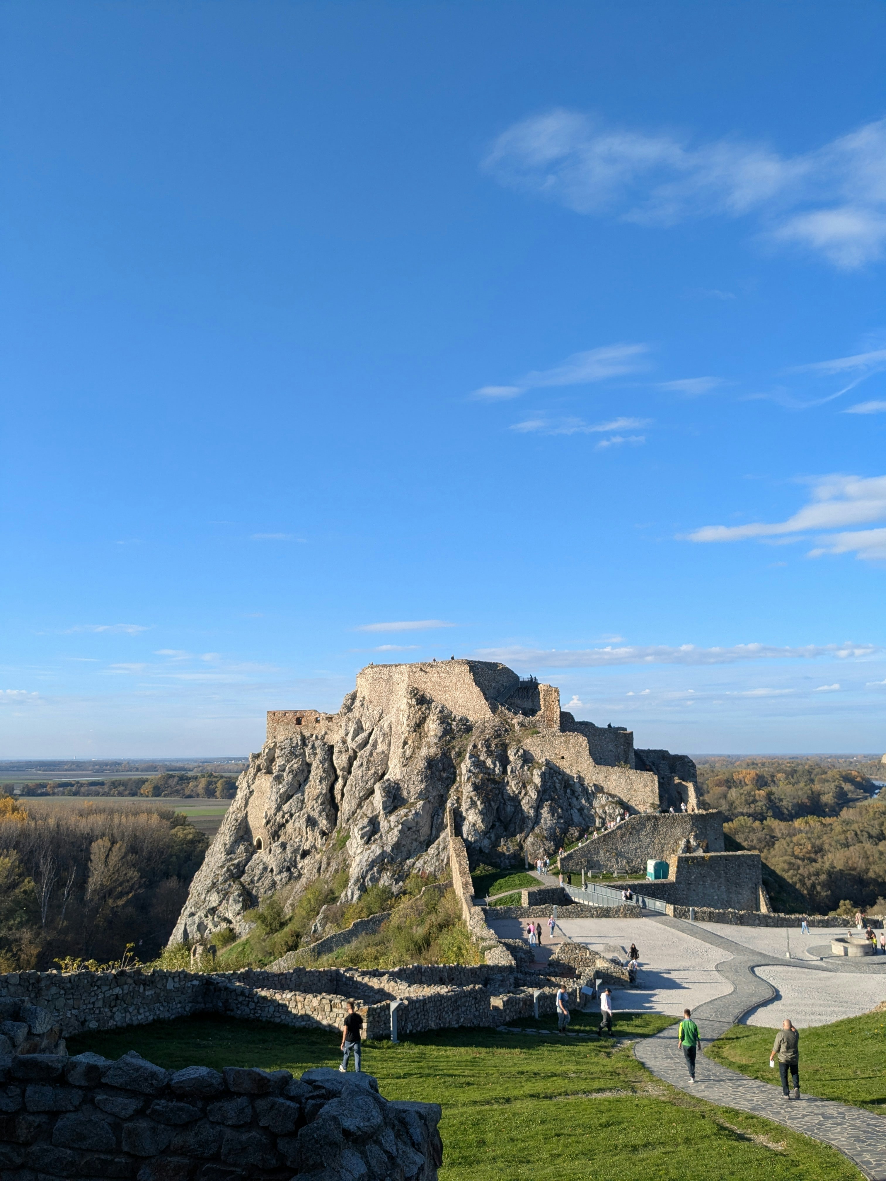 Cliffside Citadel: Sunlit Ruins Above a Winding Path