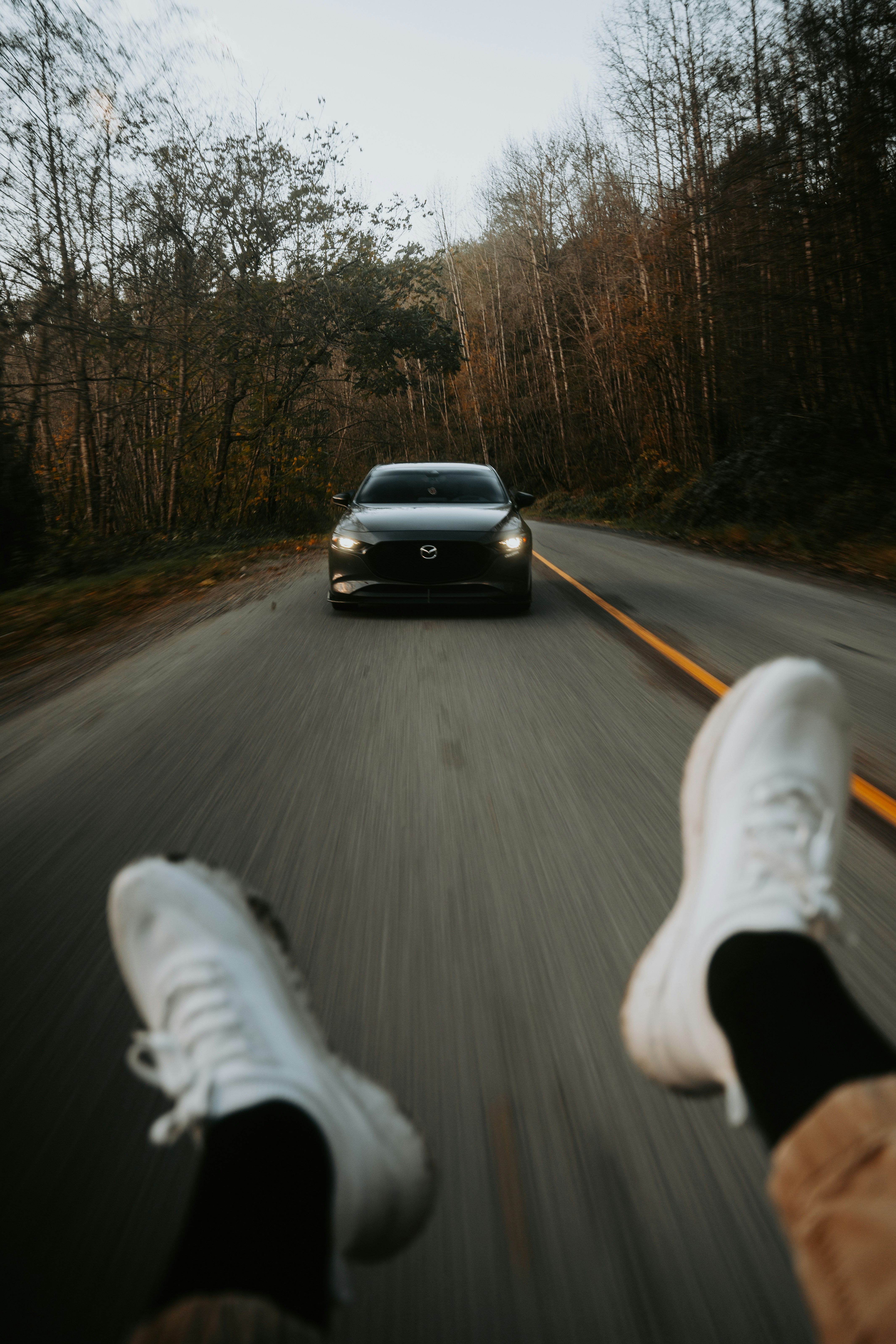 Dusk Approach: Feet-Forward Perspective on an Autumn Road