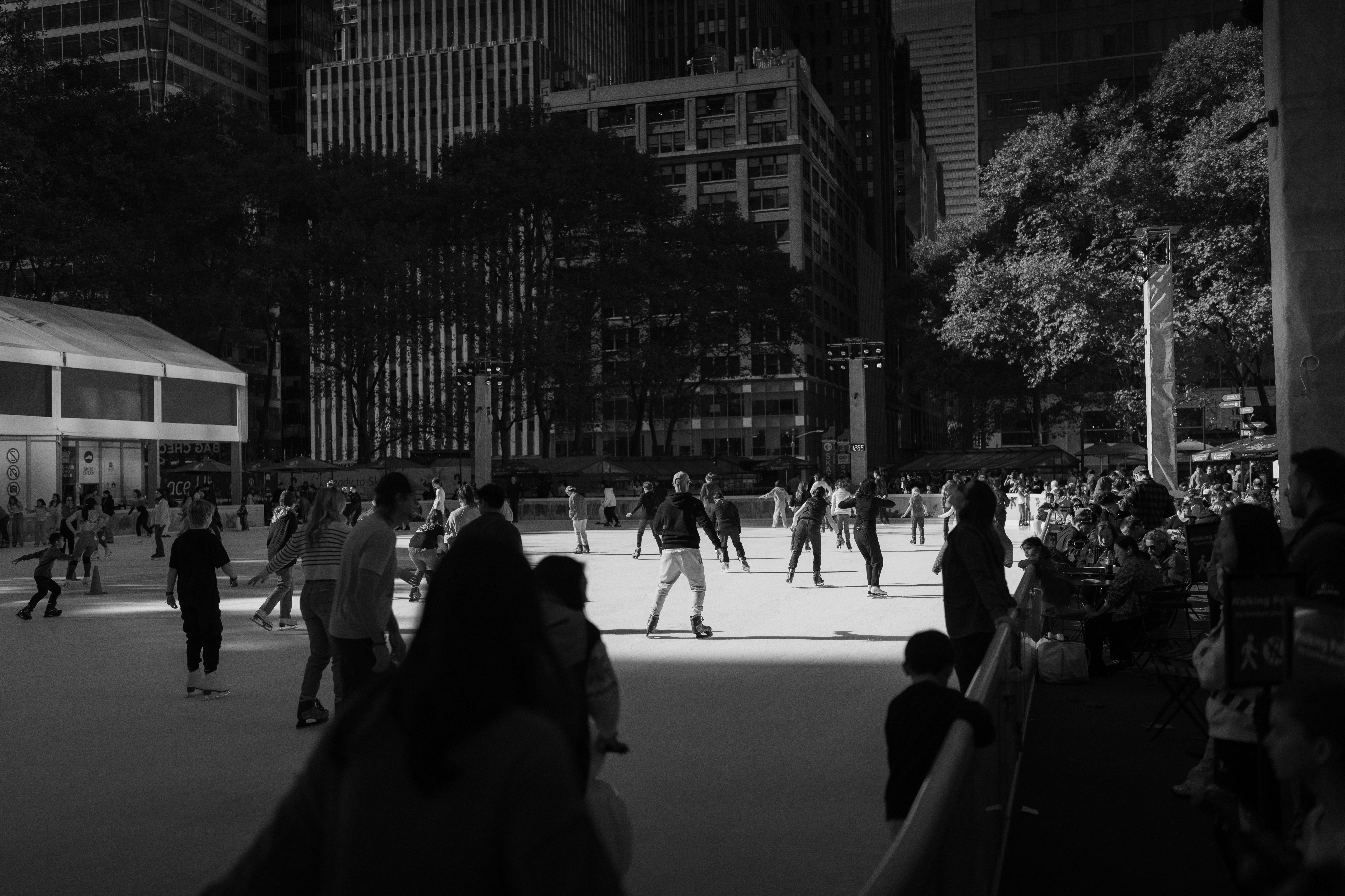 Midtown Ice: Skaters trace motion beneath glassy skyscrapers
